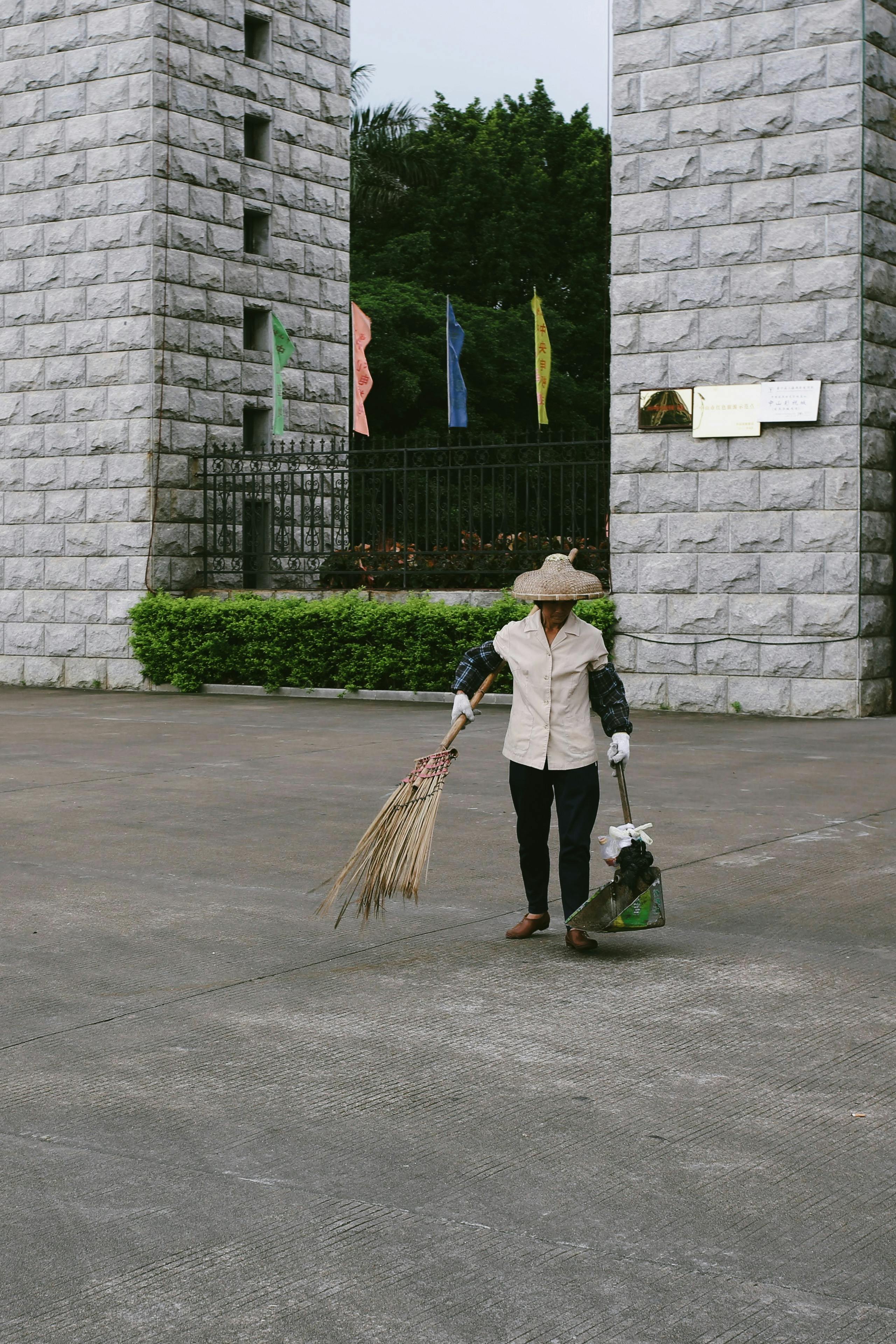 Street Sweeper in a Bamboo Hat Cleaning the Square · Free Stock Photo