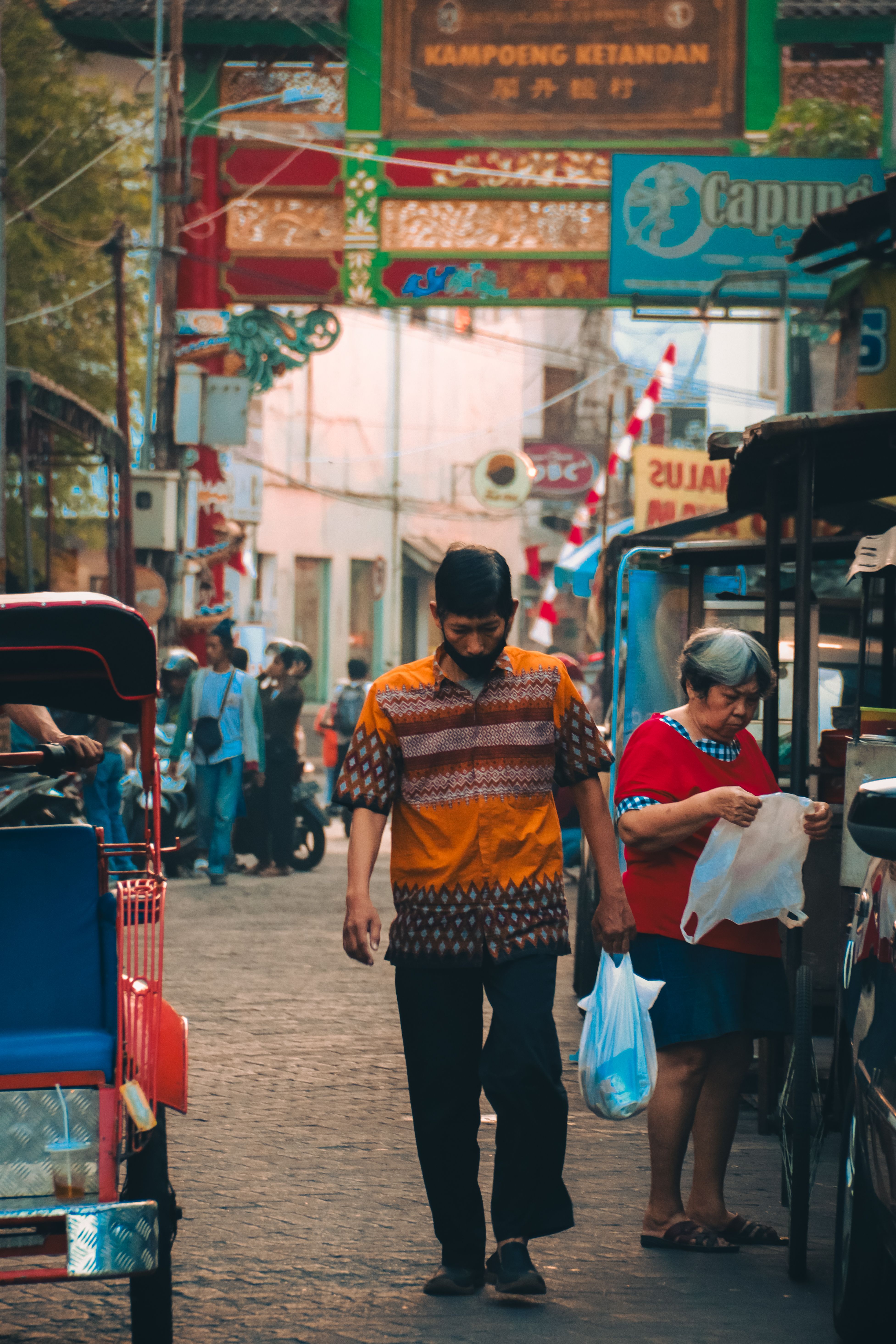 Man Carrying Products in the Bags on a Shoulder Pole · Free Stock Photo