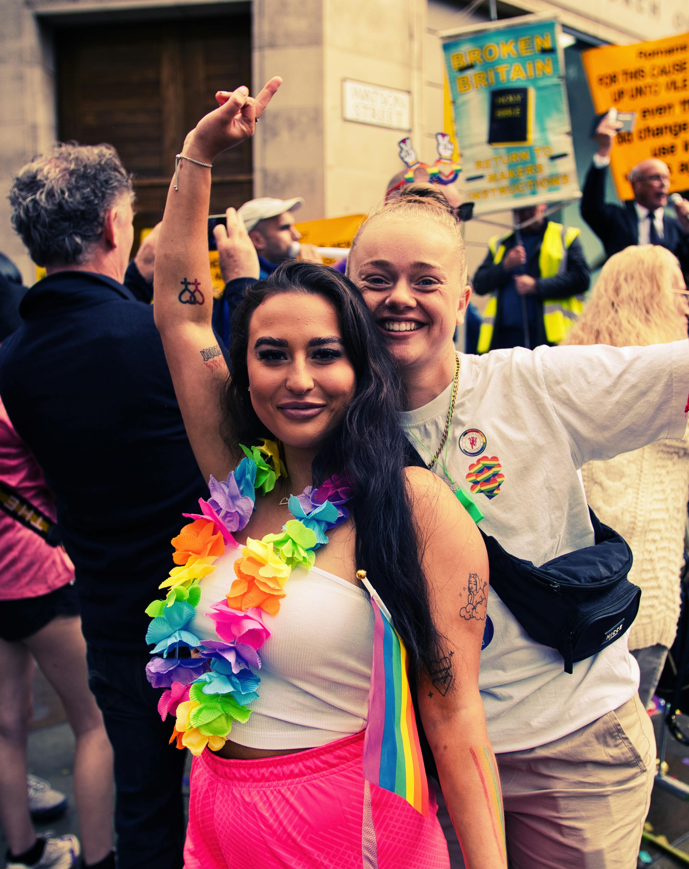 Girls at a Gay Pride with a Rainbow Flag · Free Stock Photo
