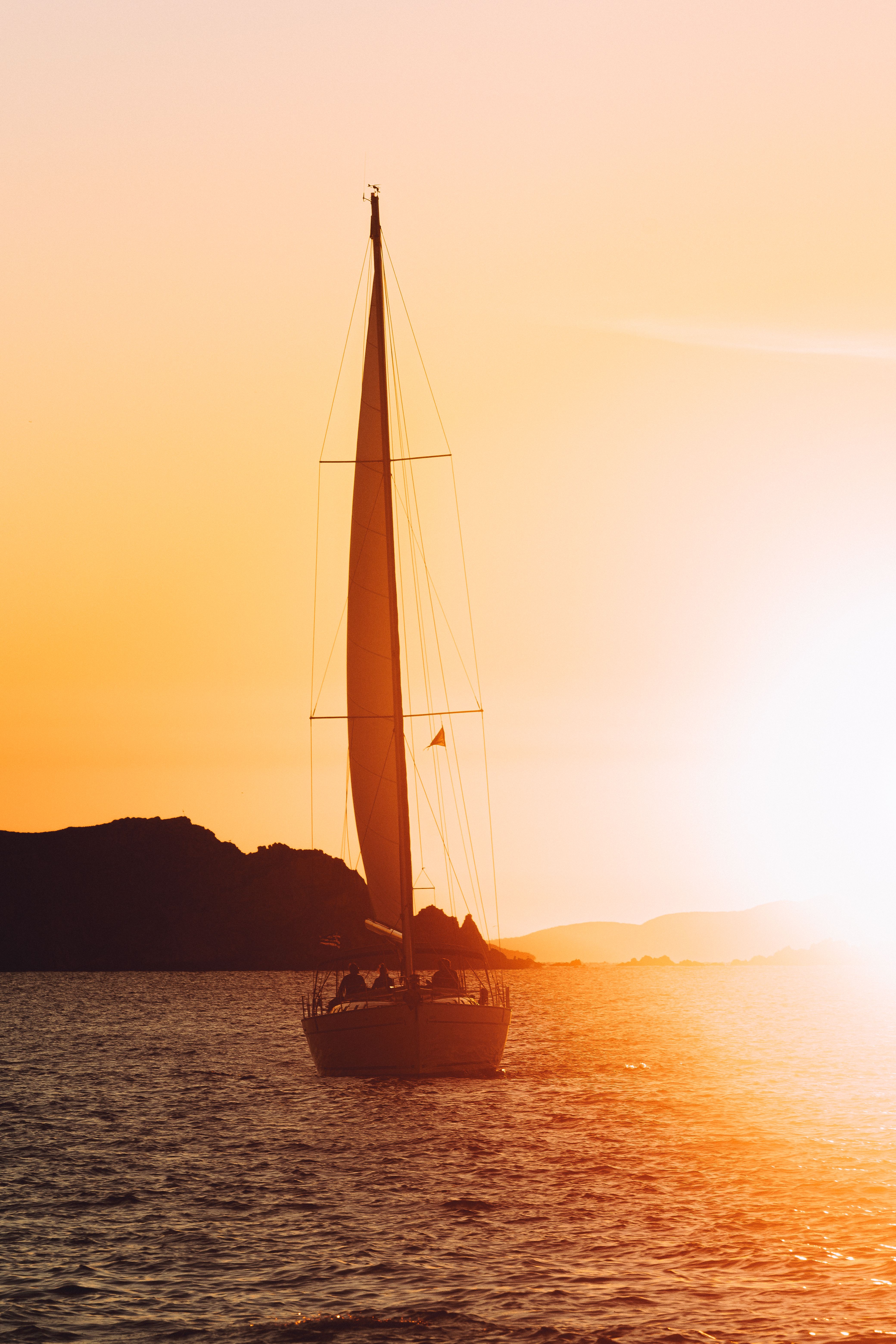 Sunset Sunlight over Sailboat on Sea Coast · Free Stock Photo