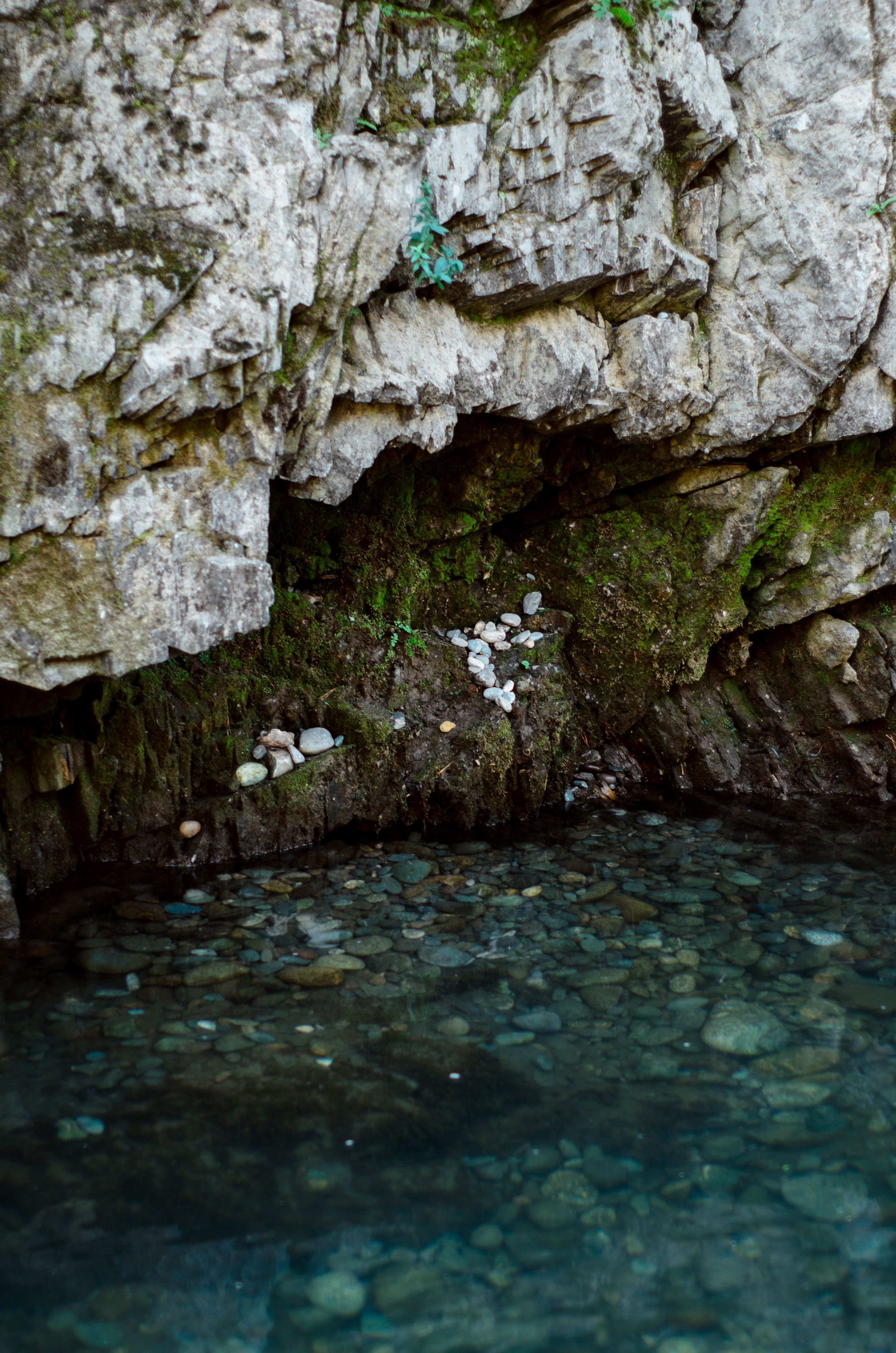 Rocky Niche in Cliff by Lake · Free Stock Photo