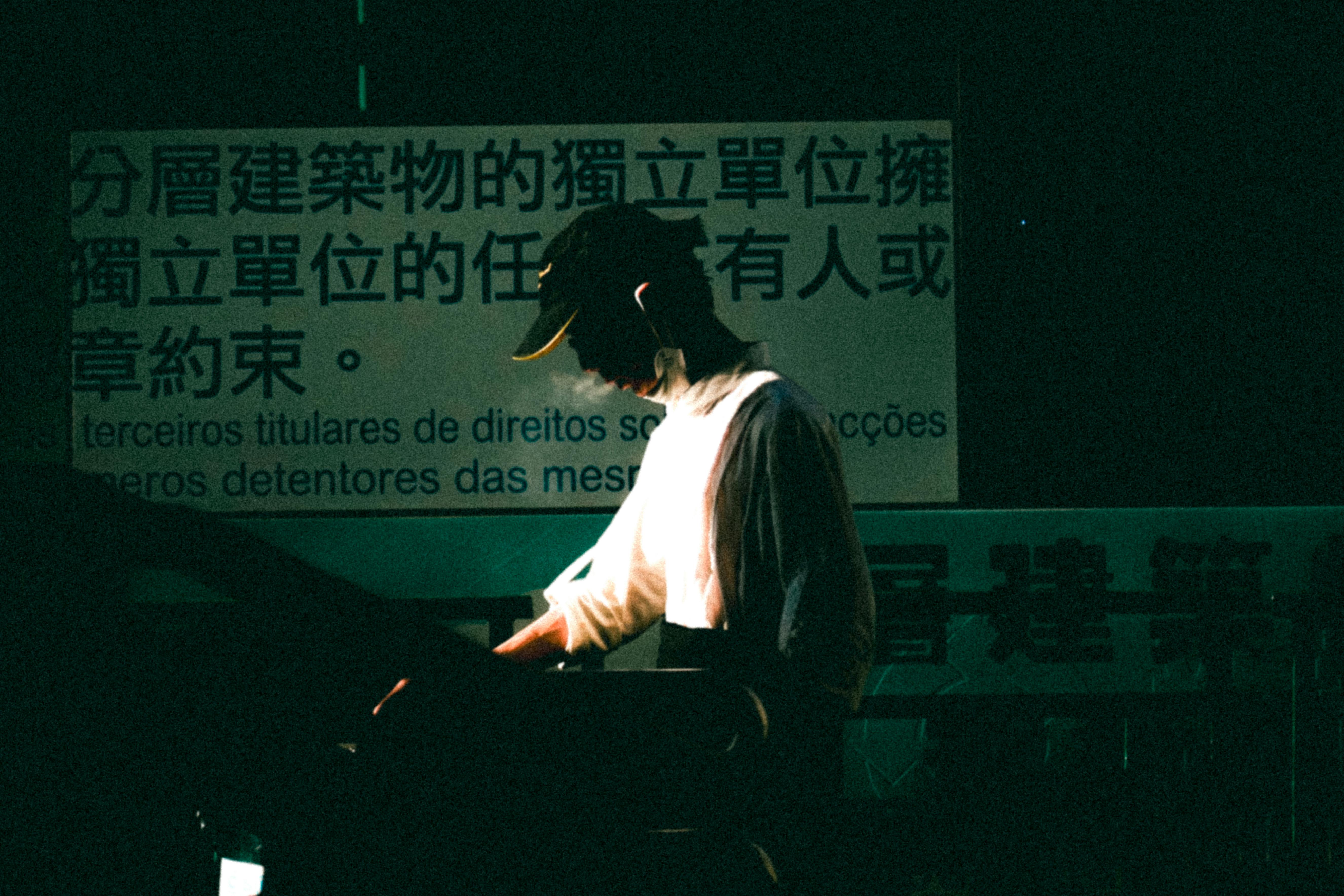 Man in Cap Standing and Working in Shadow · Free Stock Photo