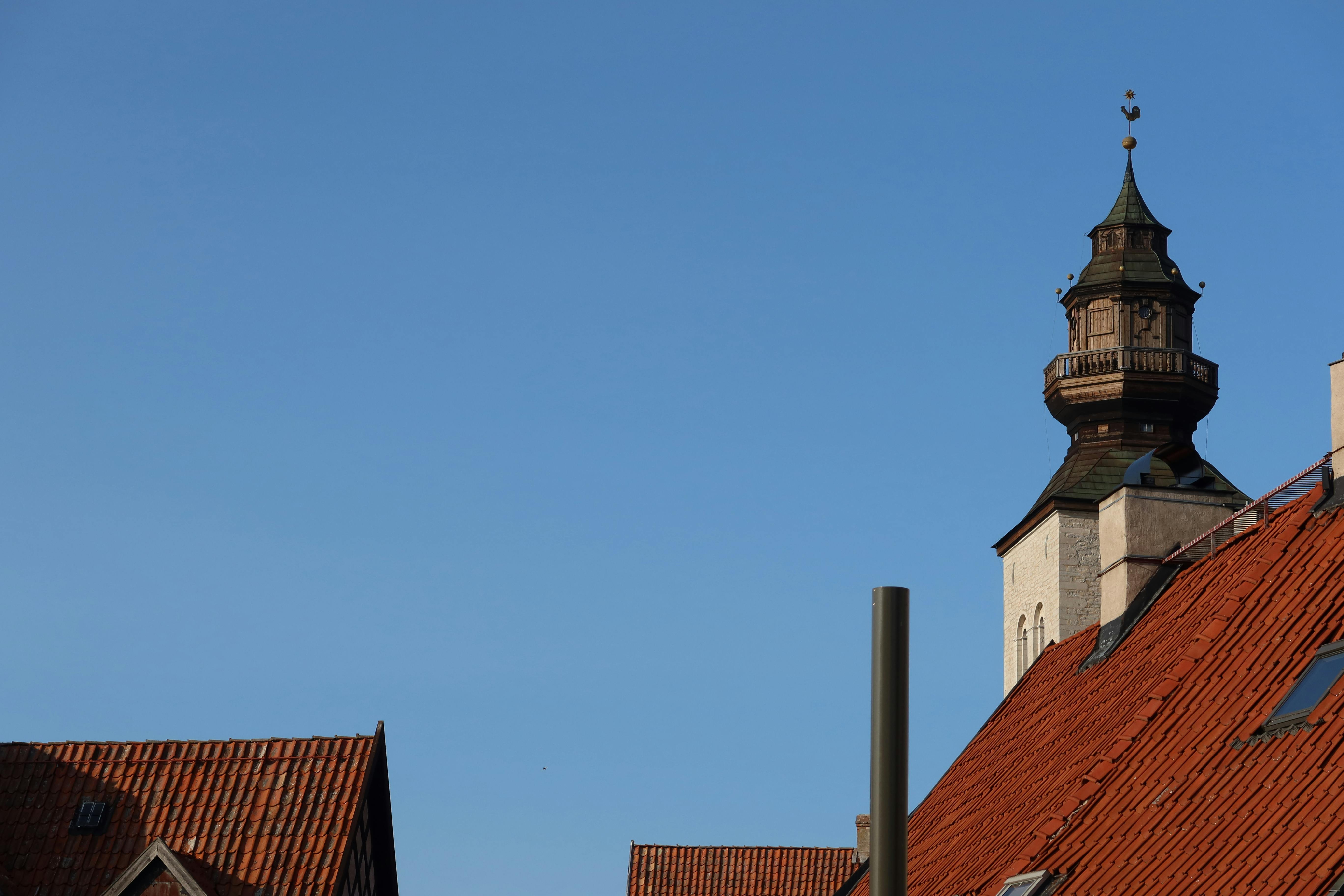 Sunlit Church Roof and Tower · Free Stock Photo
