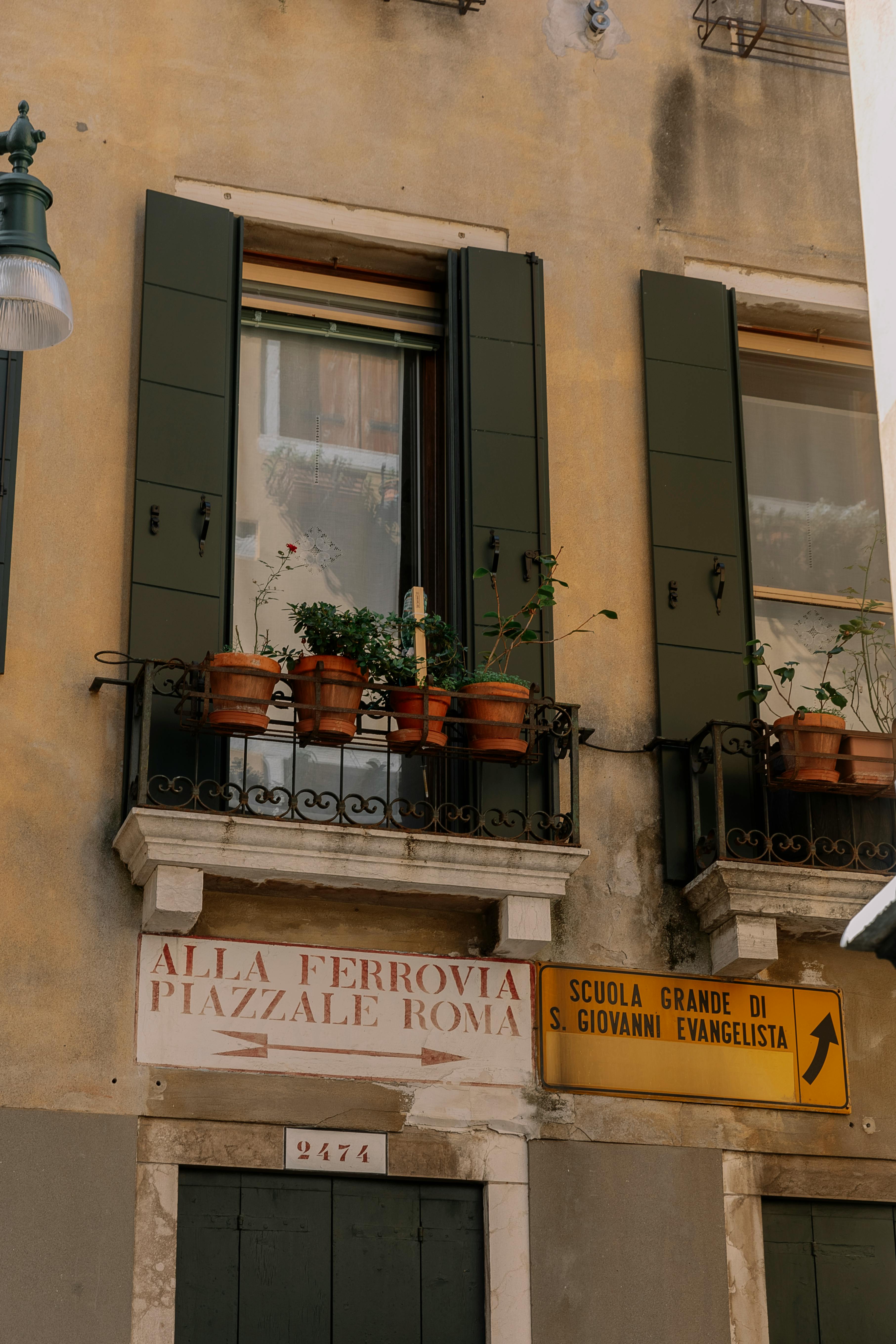 Directional Signs on Wall of Building in Town in Italy · Free Stock Photo