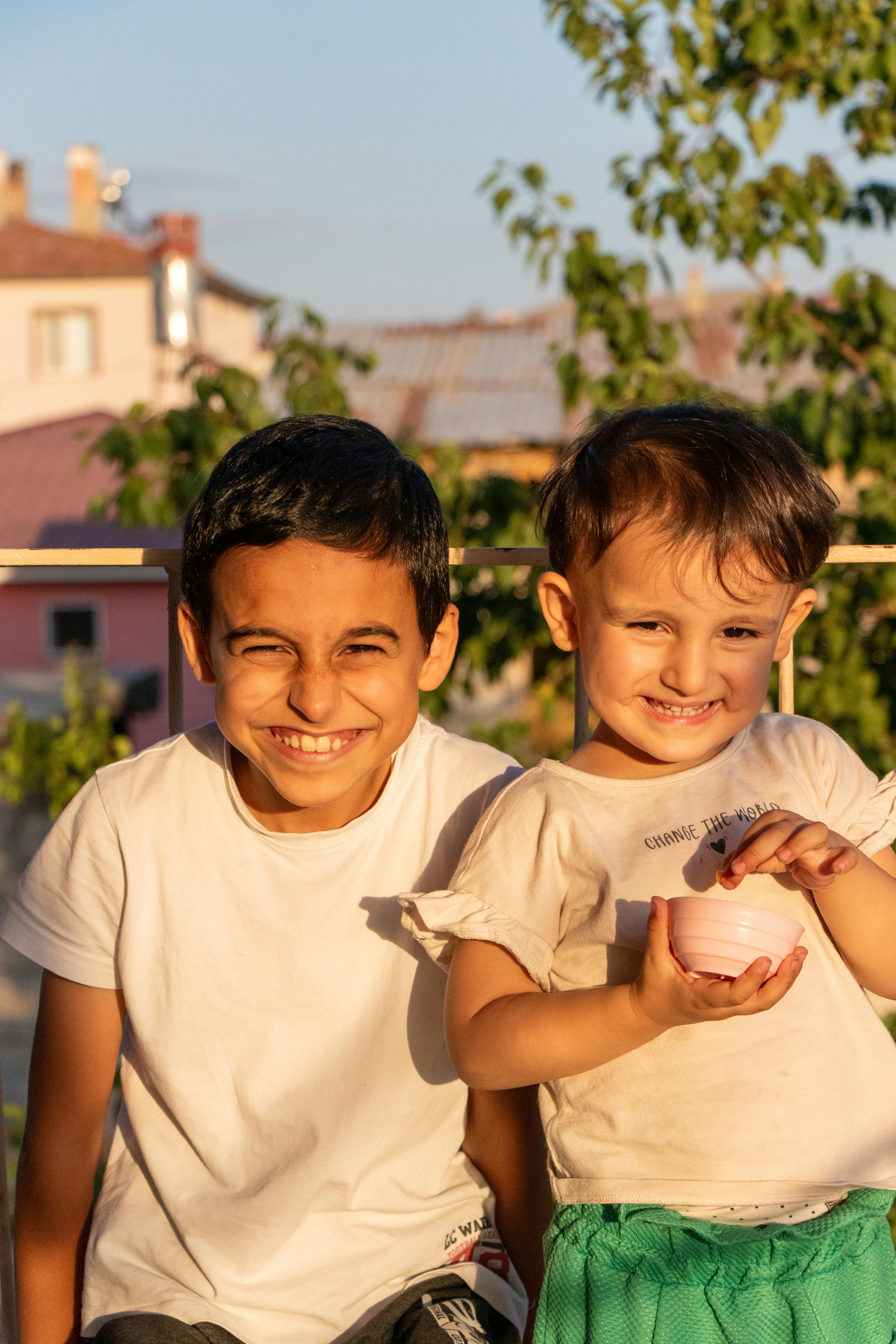 Smiling Siblings in White T-shirts · Free Stock Photo