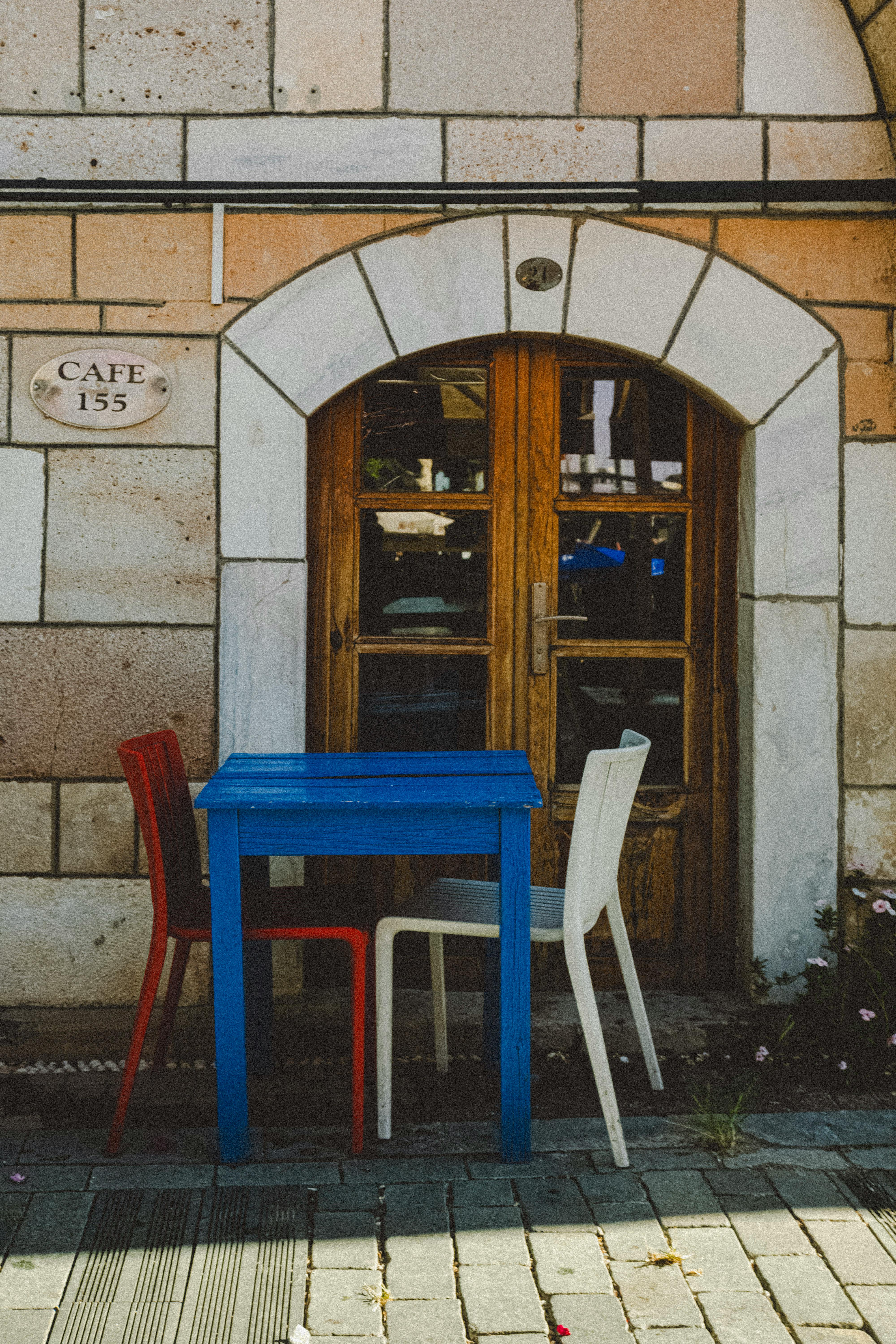 Table and Chairs near Cafe Door · Free Stock Photo