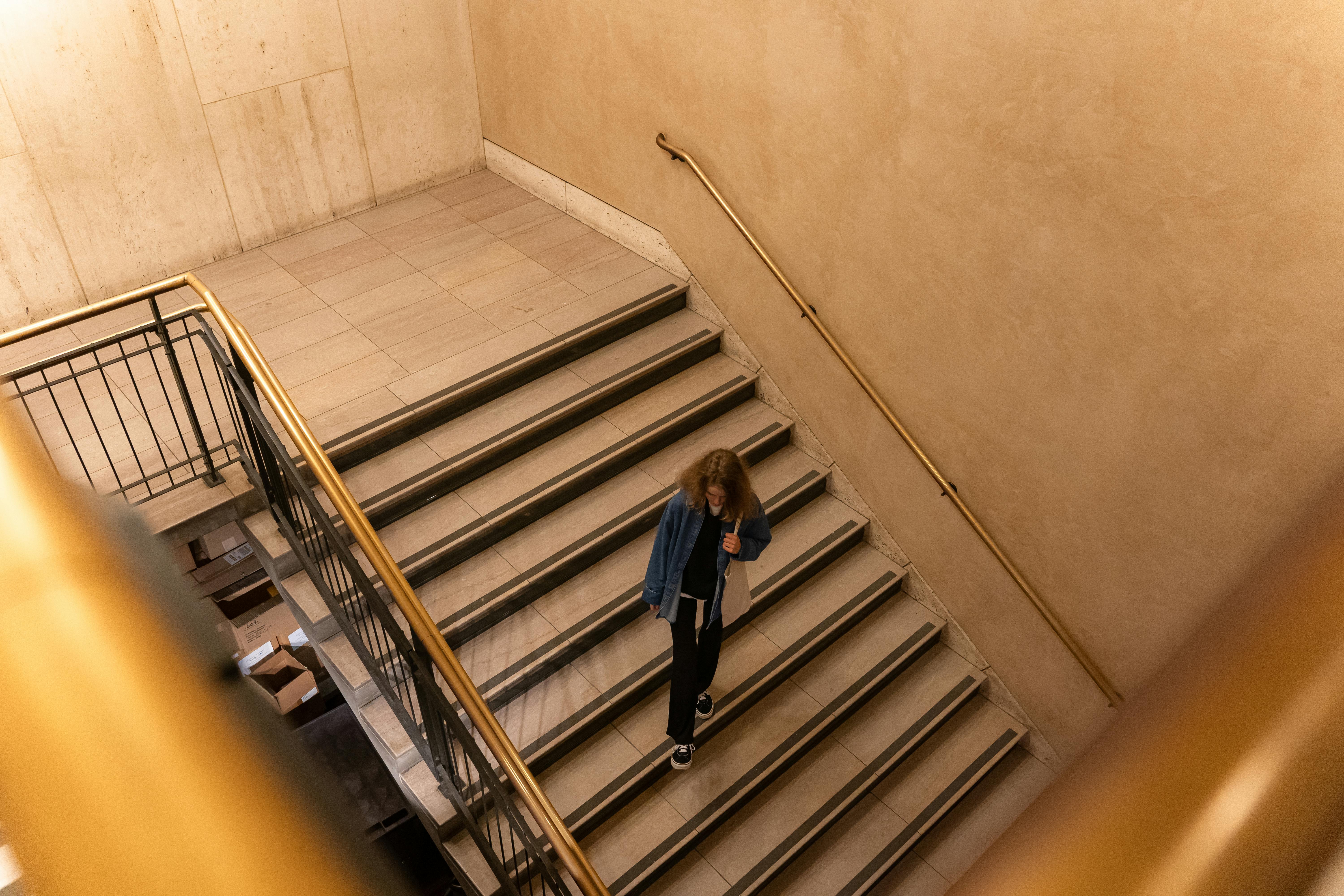 High Angle Shot of a Person Walking Down the Stairs · Free Stock Photo