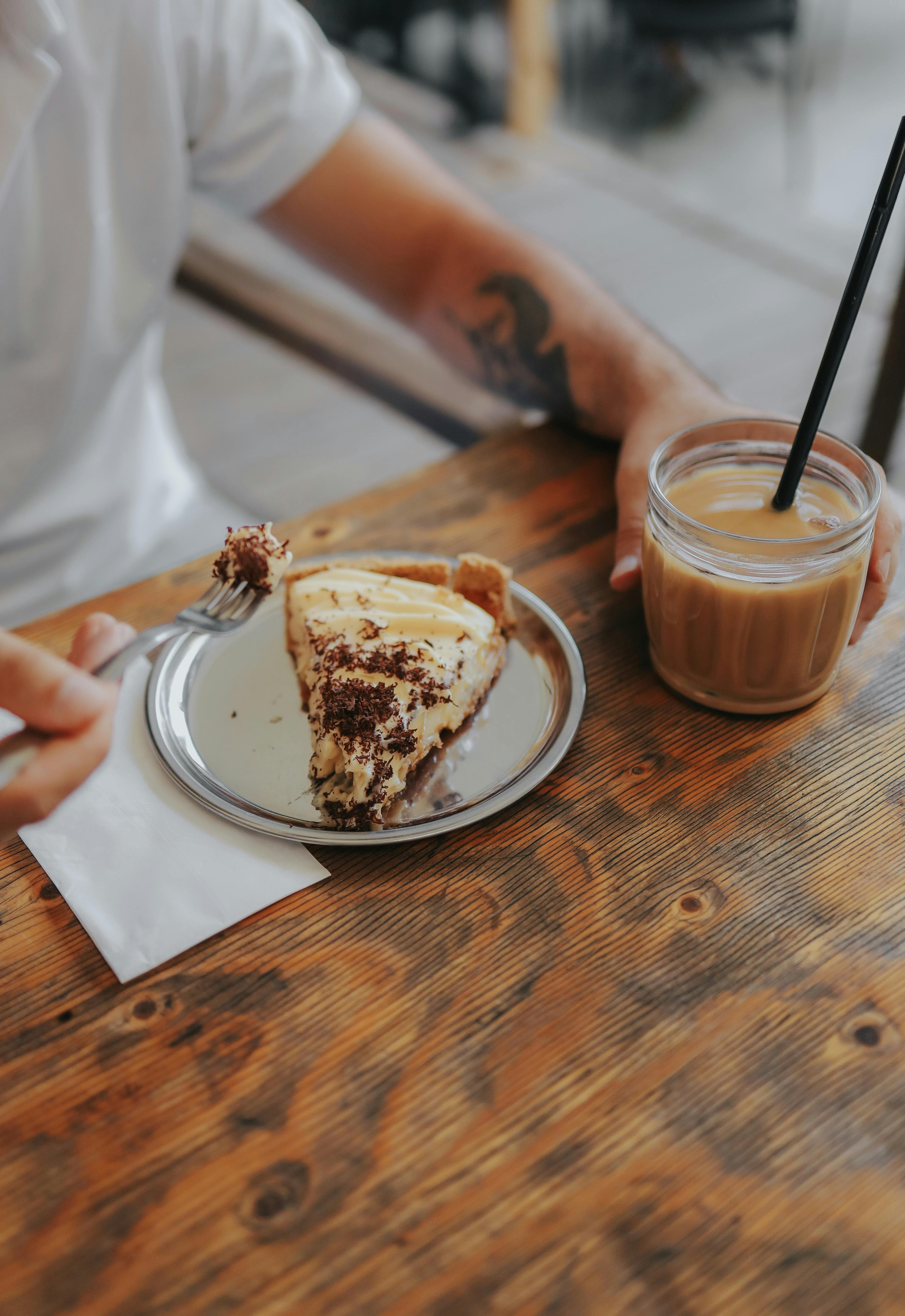 Man Eating Cheesecake and Holding Drink · Free Stock Photo