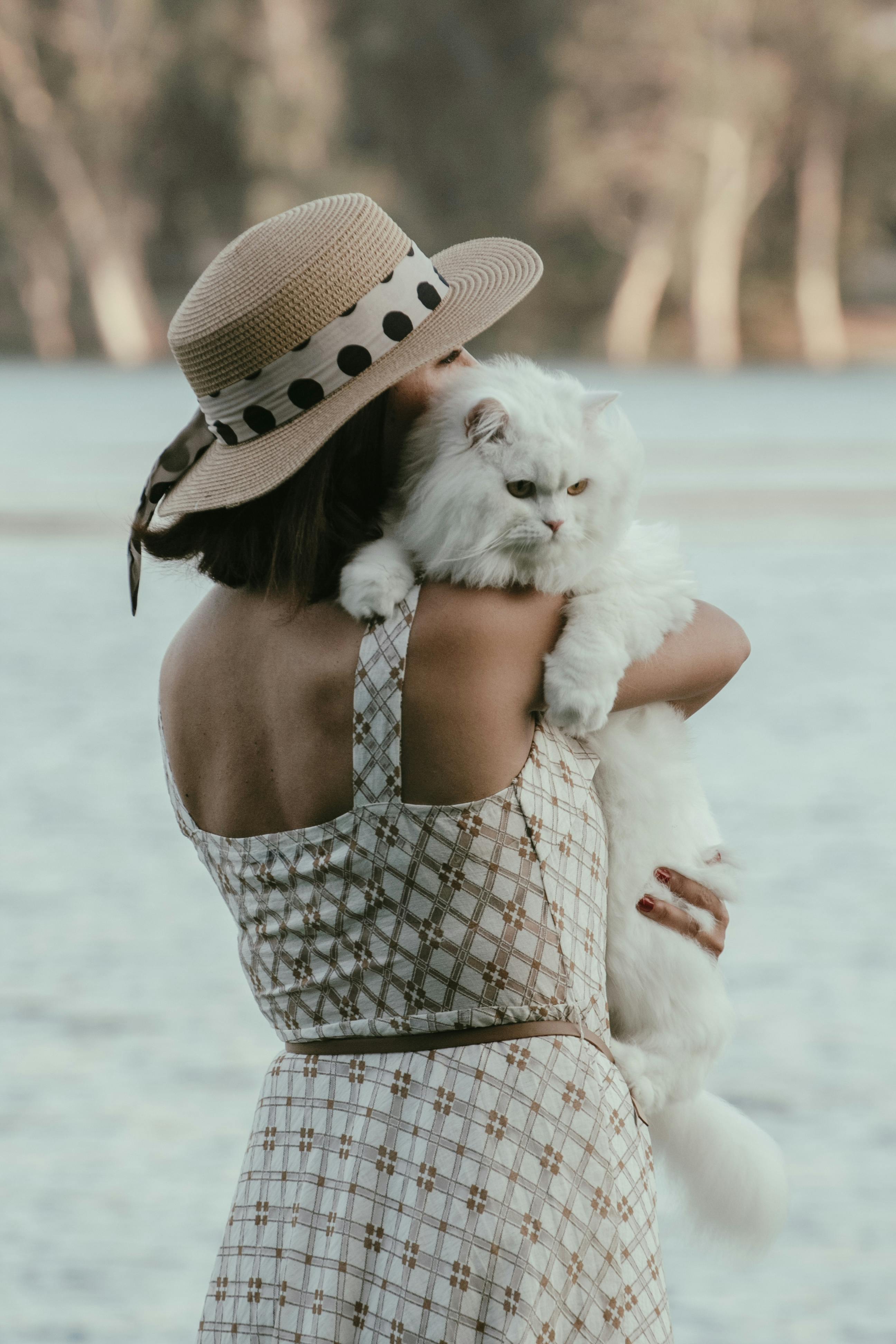 Woman Carrying a Cat · Free Stock Photo