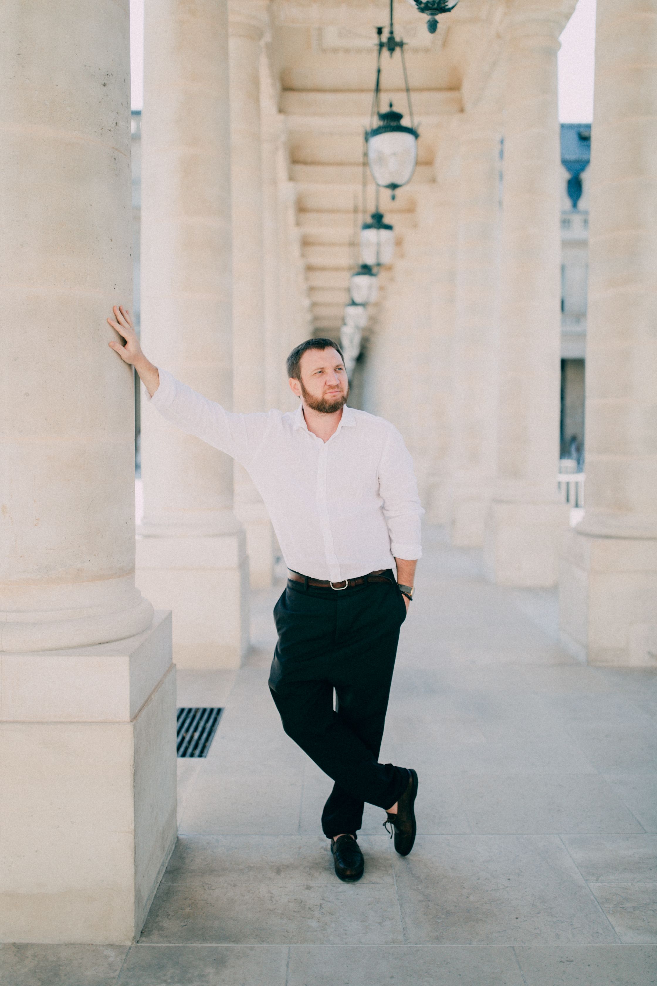 Elegant Man Resting against Column · Free Stock Photo