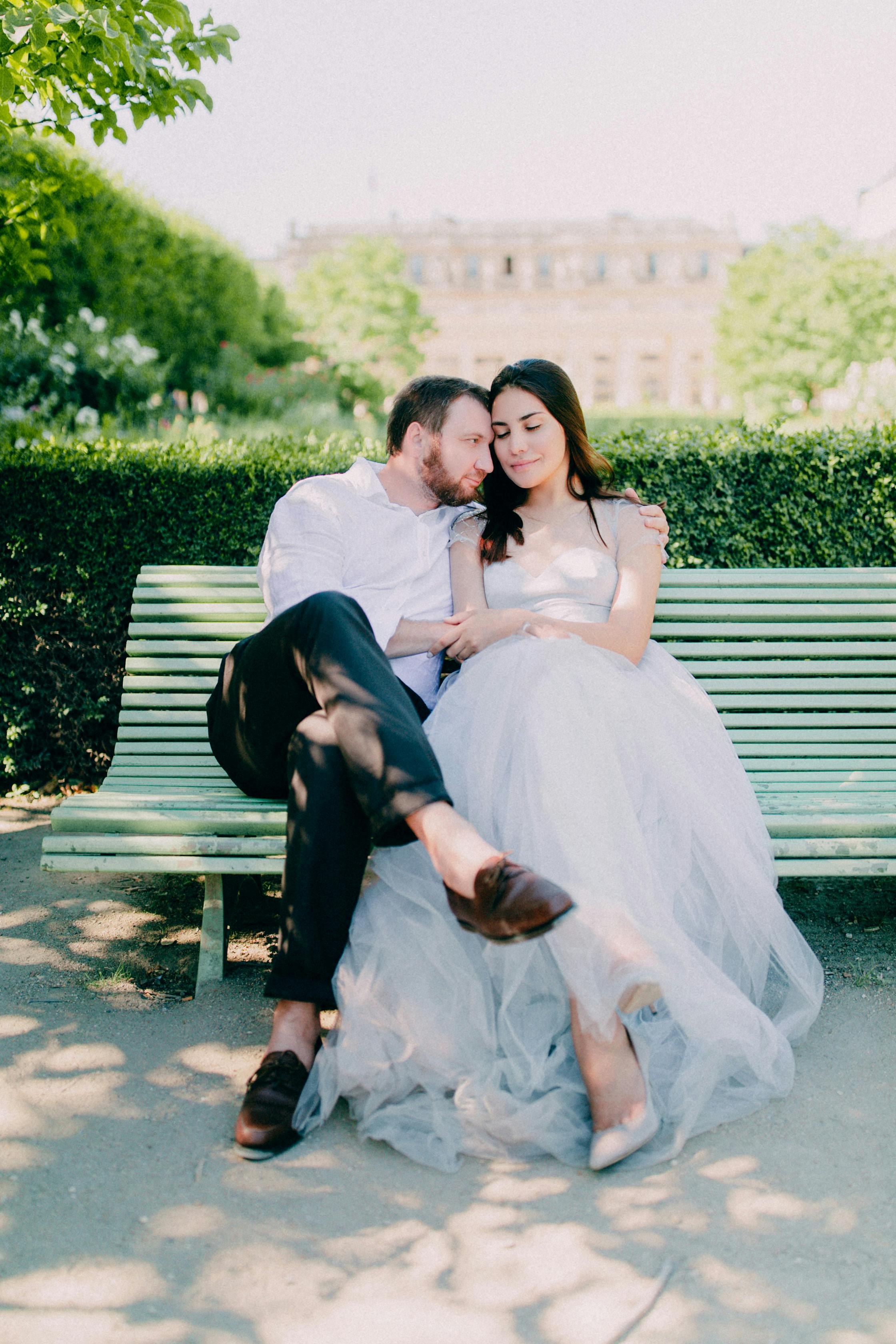 Elegant Couple Sitting on Bench in Shadow · Free Stock Photo