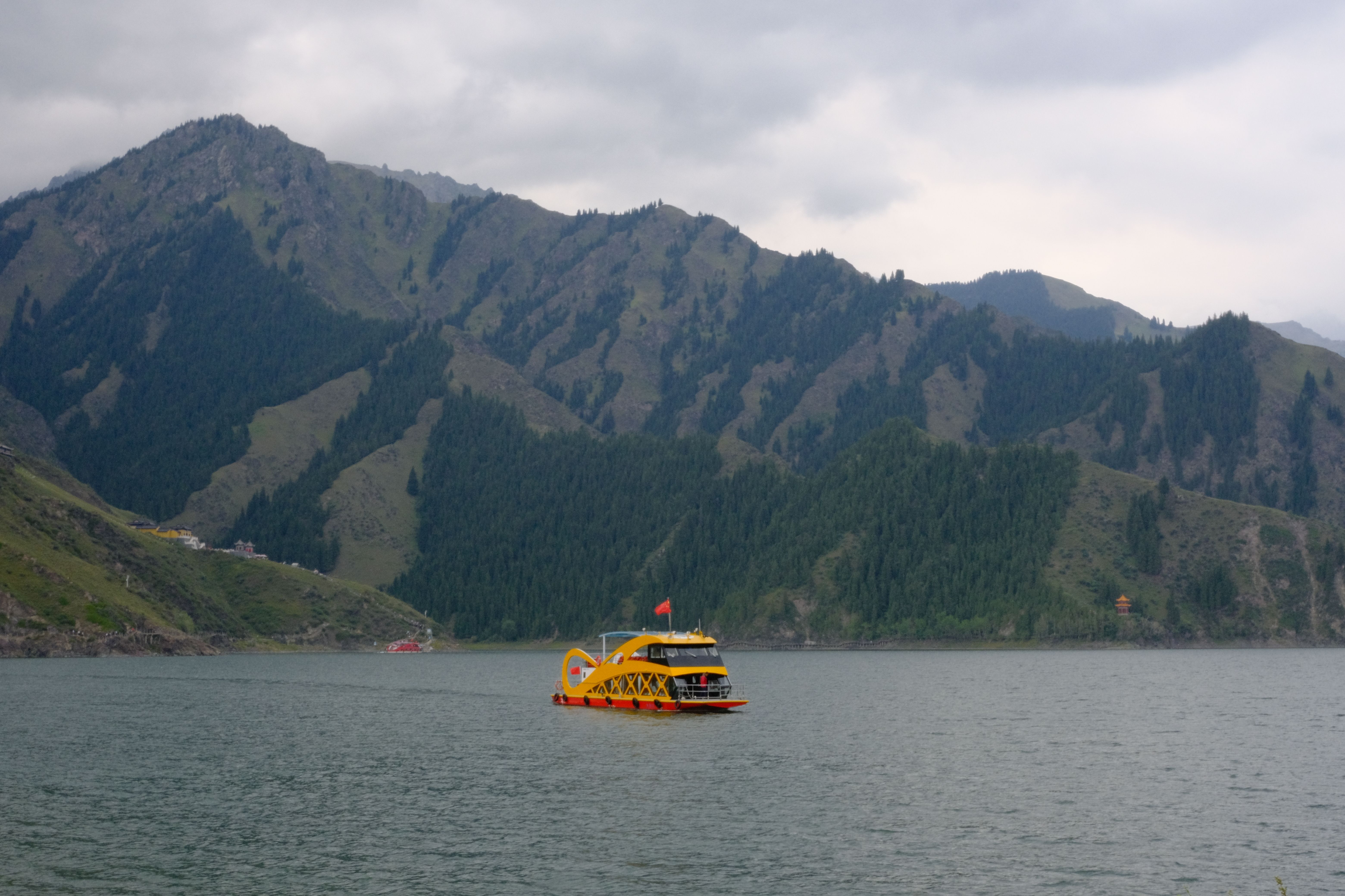Yellow Ship Sailing on Lake against Mountains · Free Stock Photo