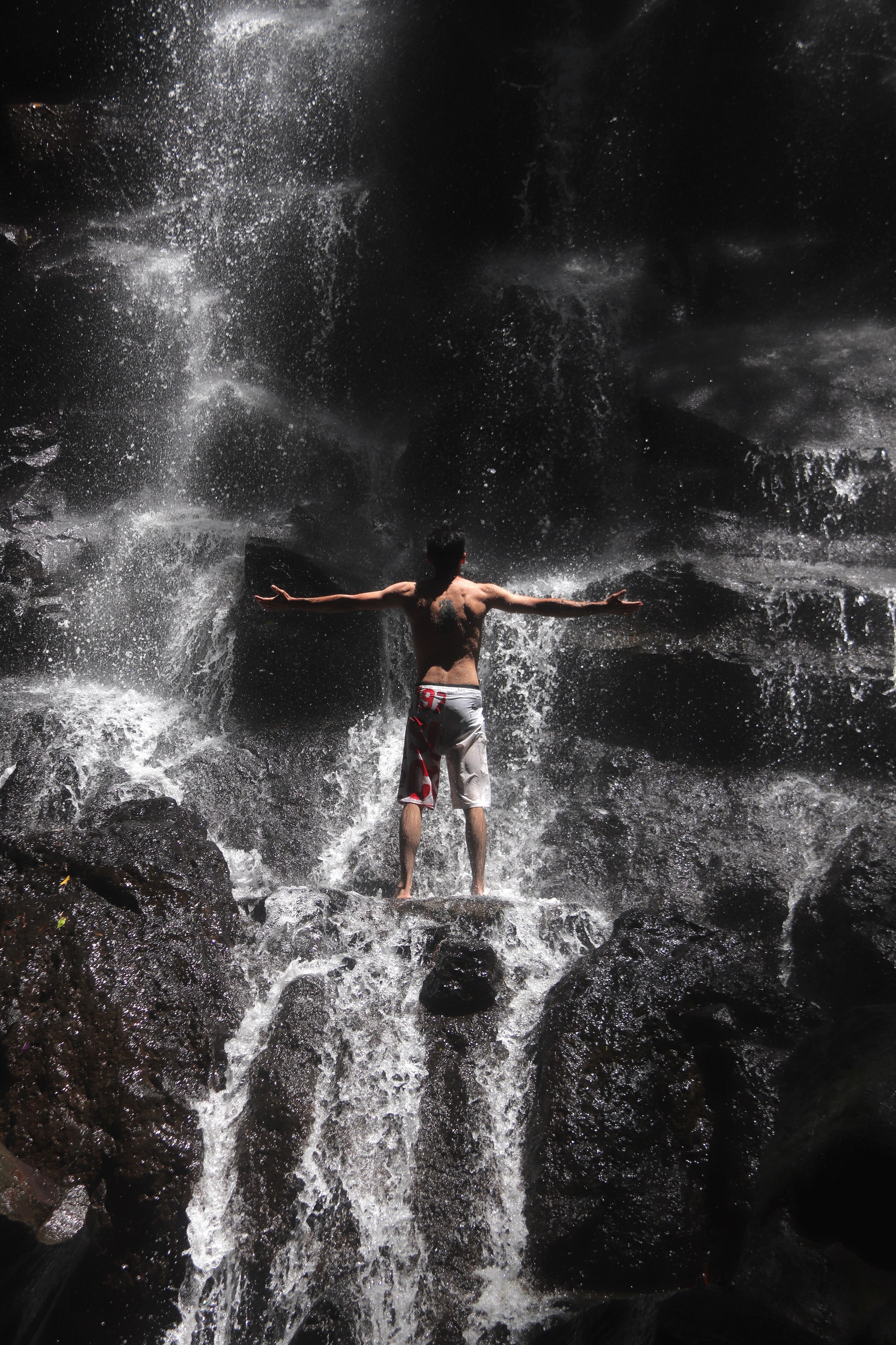 A Person Standing by a Waterfall · Free Stock Photo