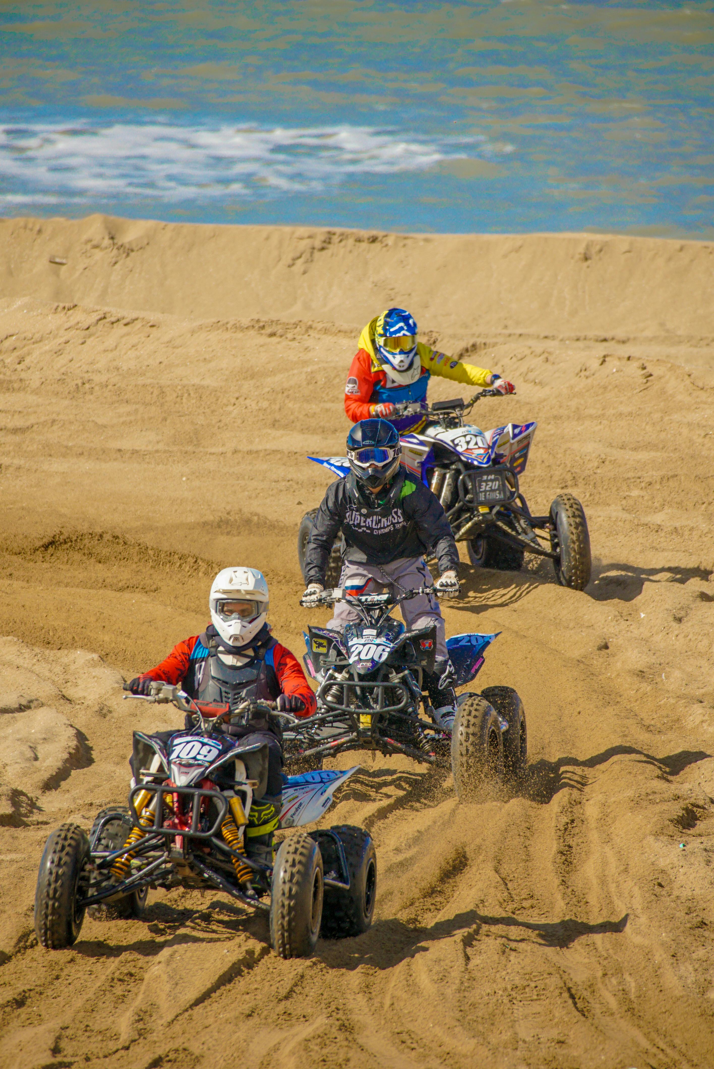 People Riding on Quad Bikes in the Desert · Free Stock Photo