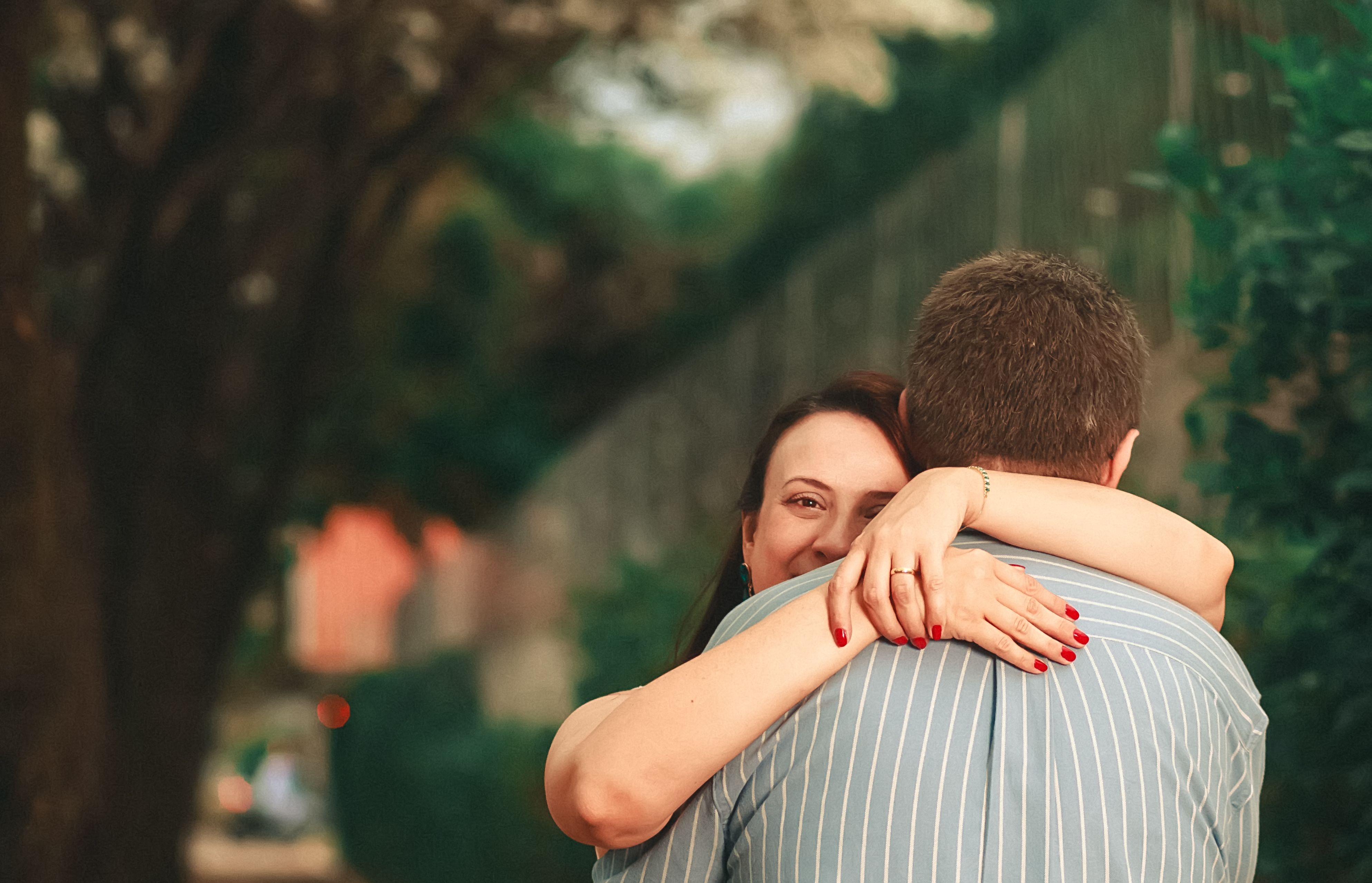 Woman with Nails Painted Red Hugging Man · Free Stock Photo