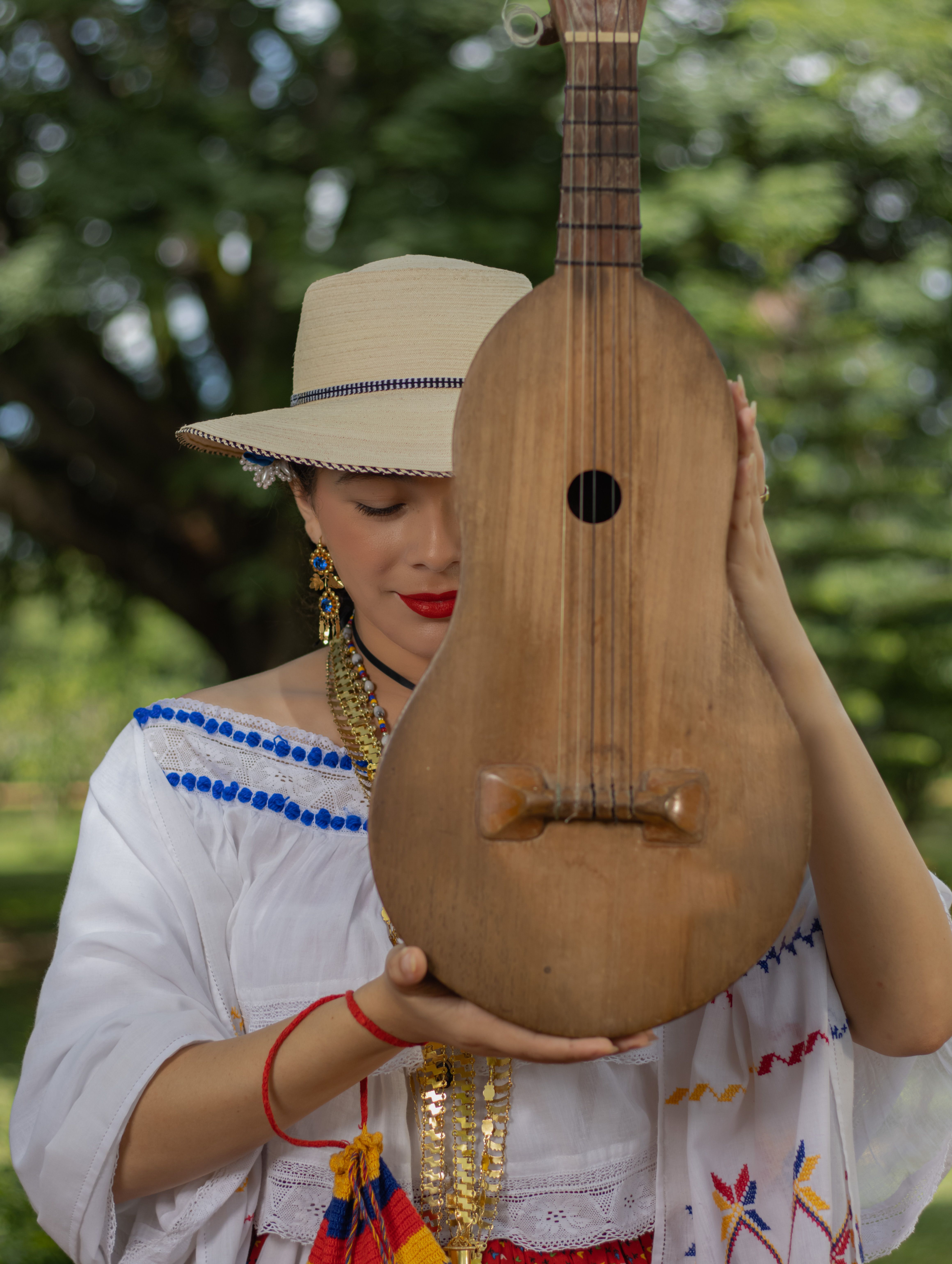 Woman in Wide Brimmed Hat Holding a Stringed Musical Instrument · Free ...