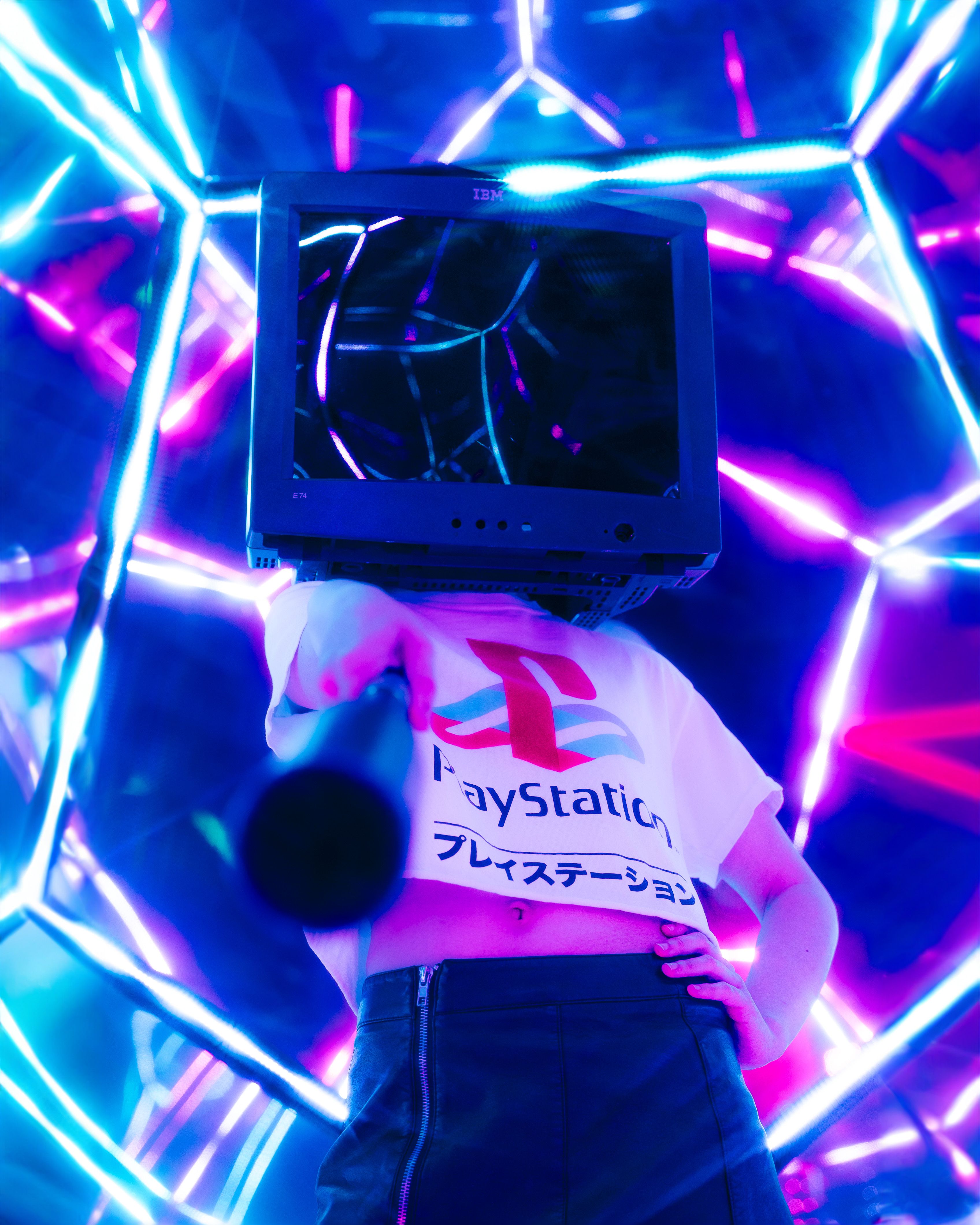 Person Wearing TV on their Head Standing on Bright Neon Background ...