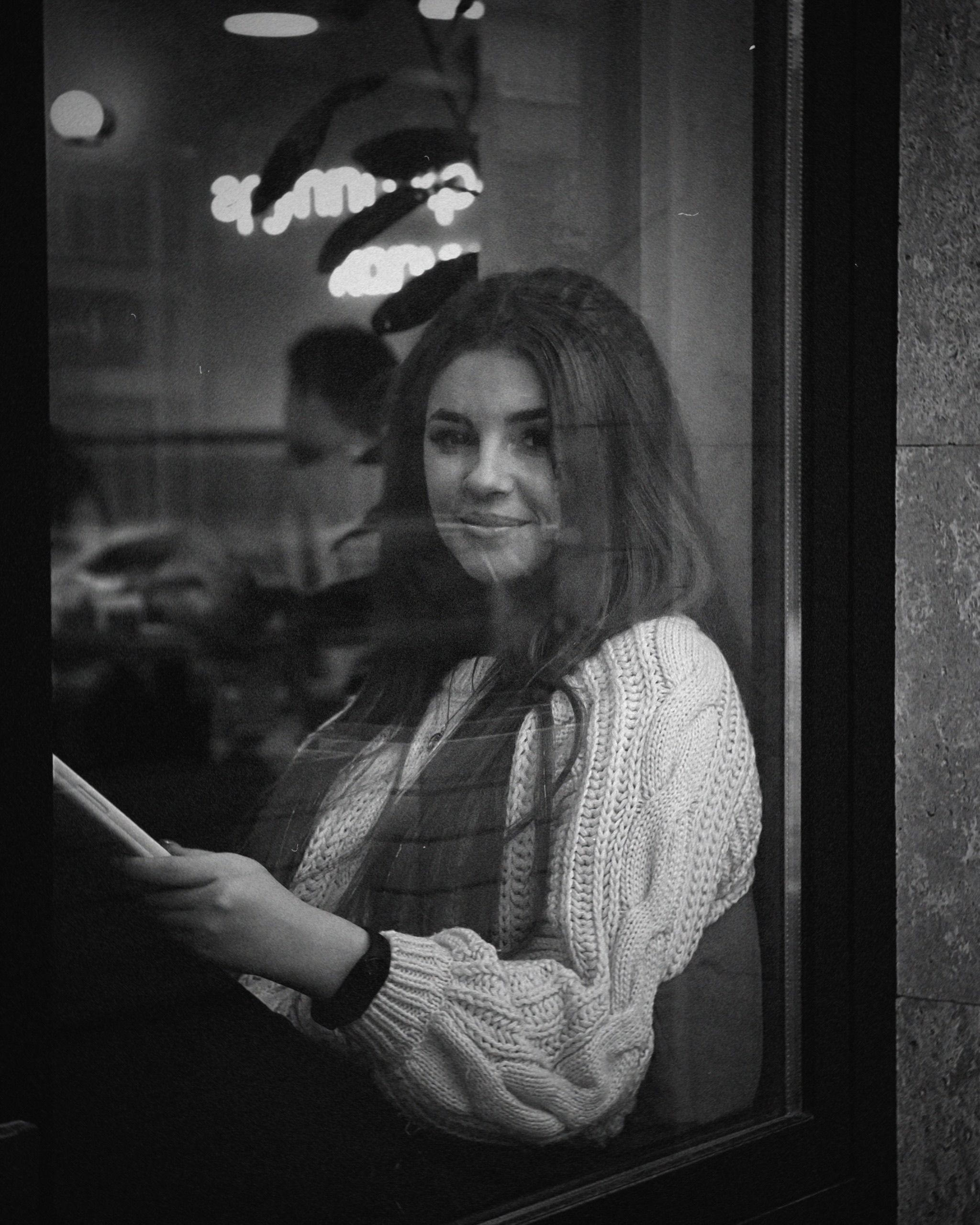Smiling Woman behind the Window · Free Stock Photo