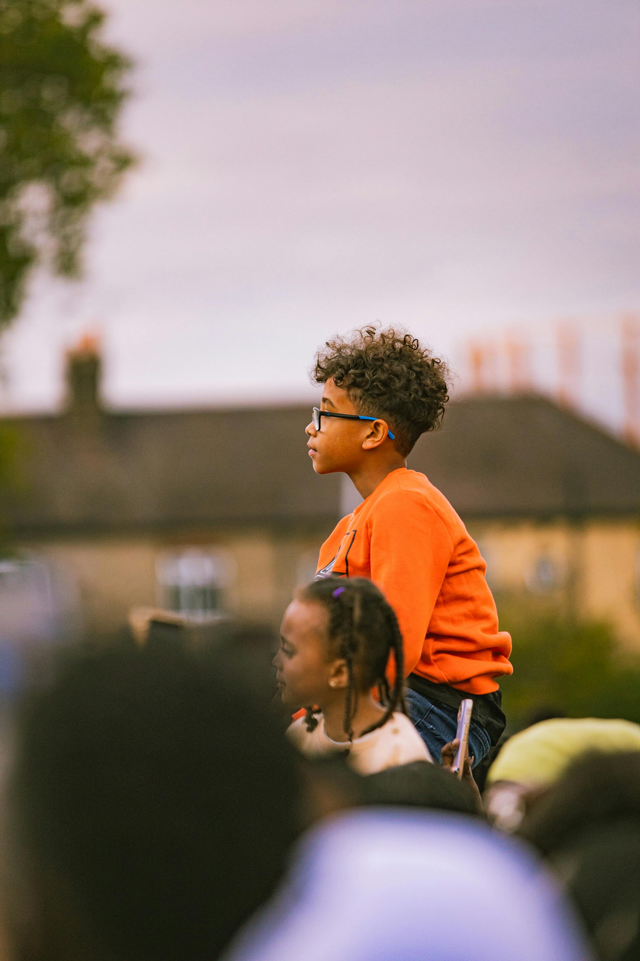 Teenage Boy being Piggybacked in a Crowd · Free Stock Photo