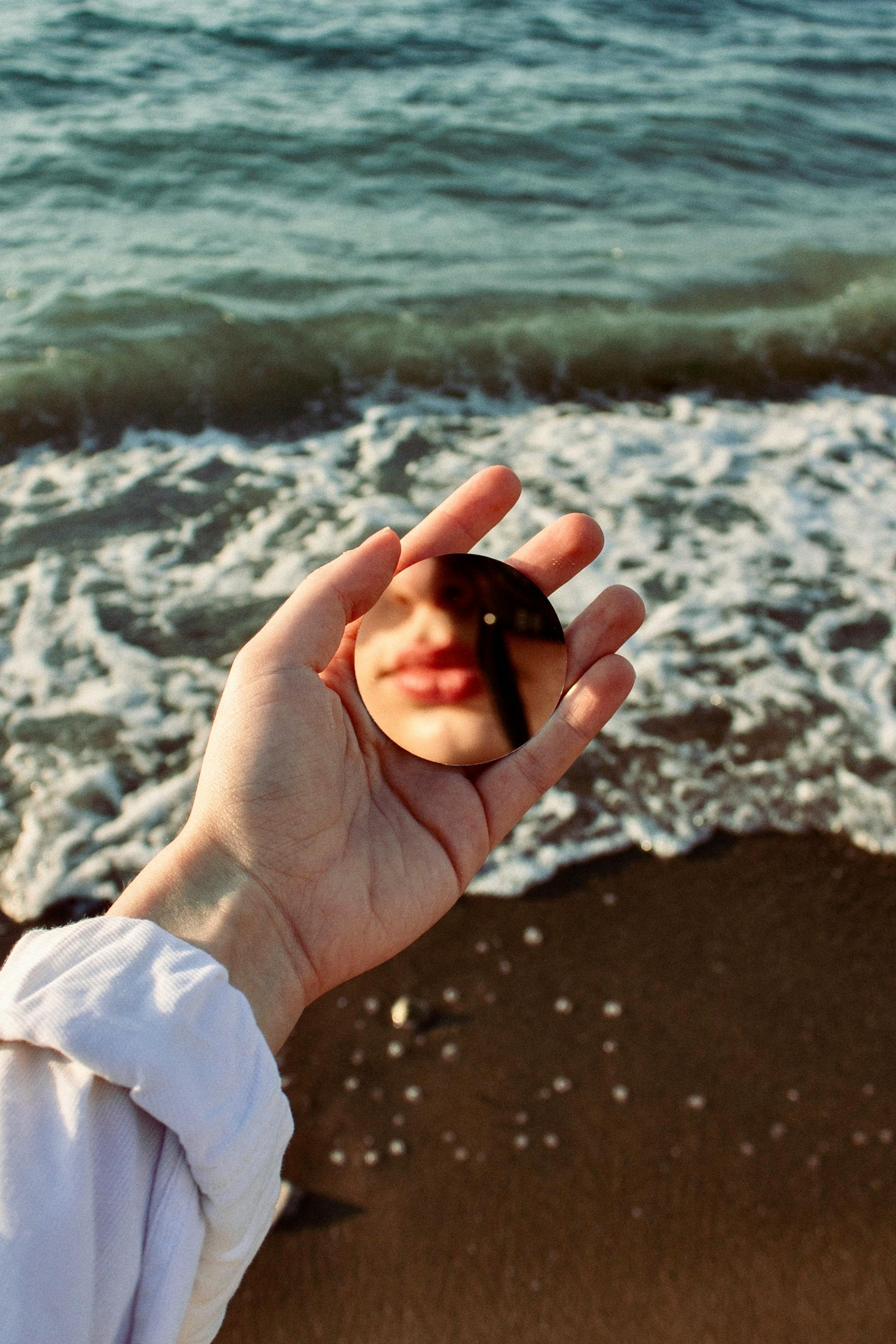 Reflection of Womans Face in a Mirror against Beach · Free Stock Photo