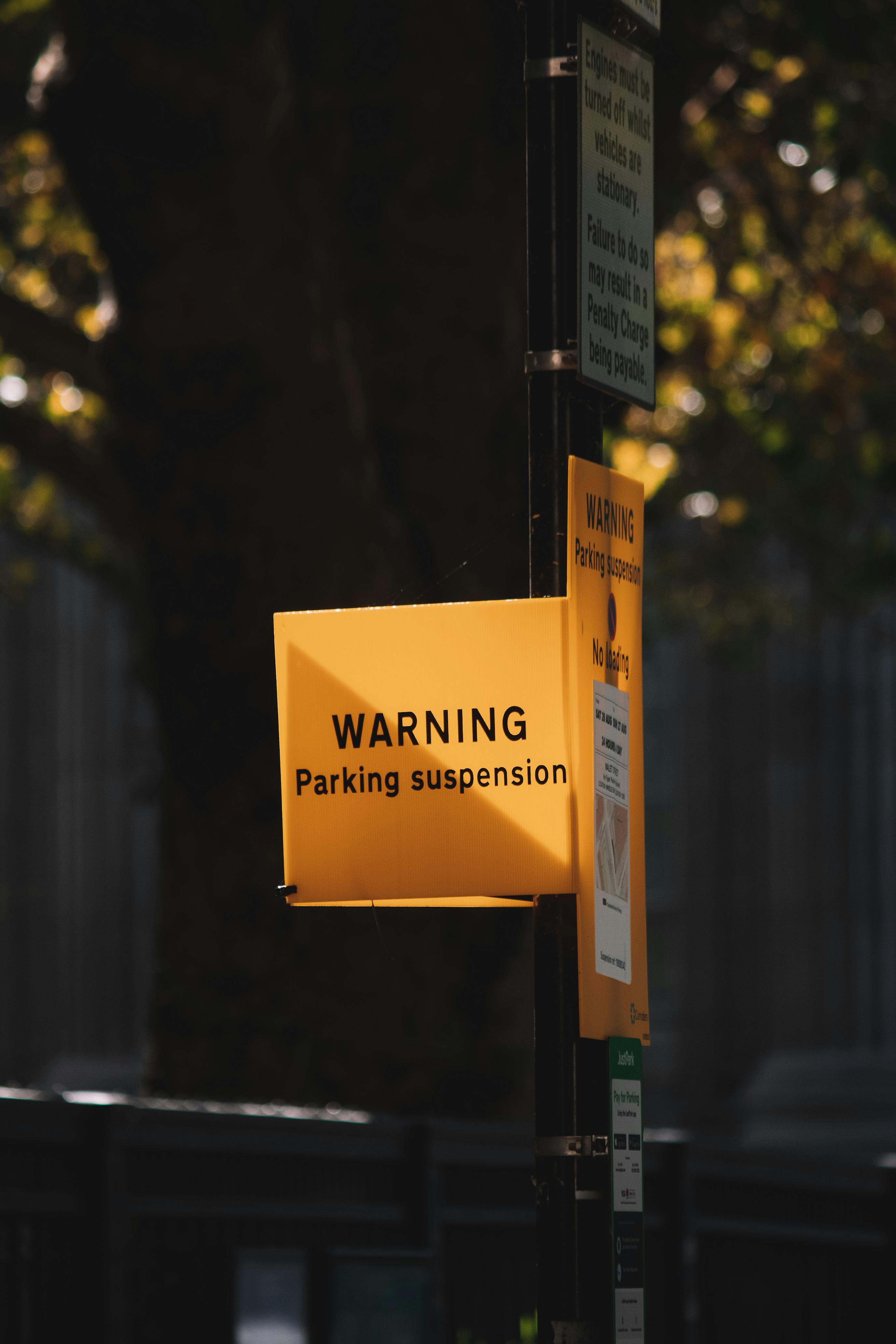 Parking Suspension Warning Sign on a Post · Free Stock Photo