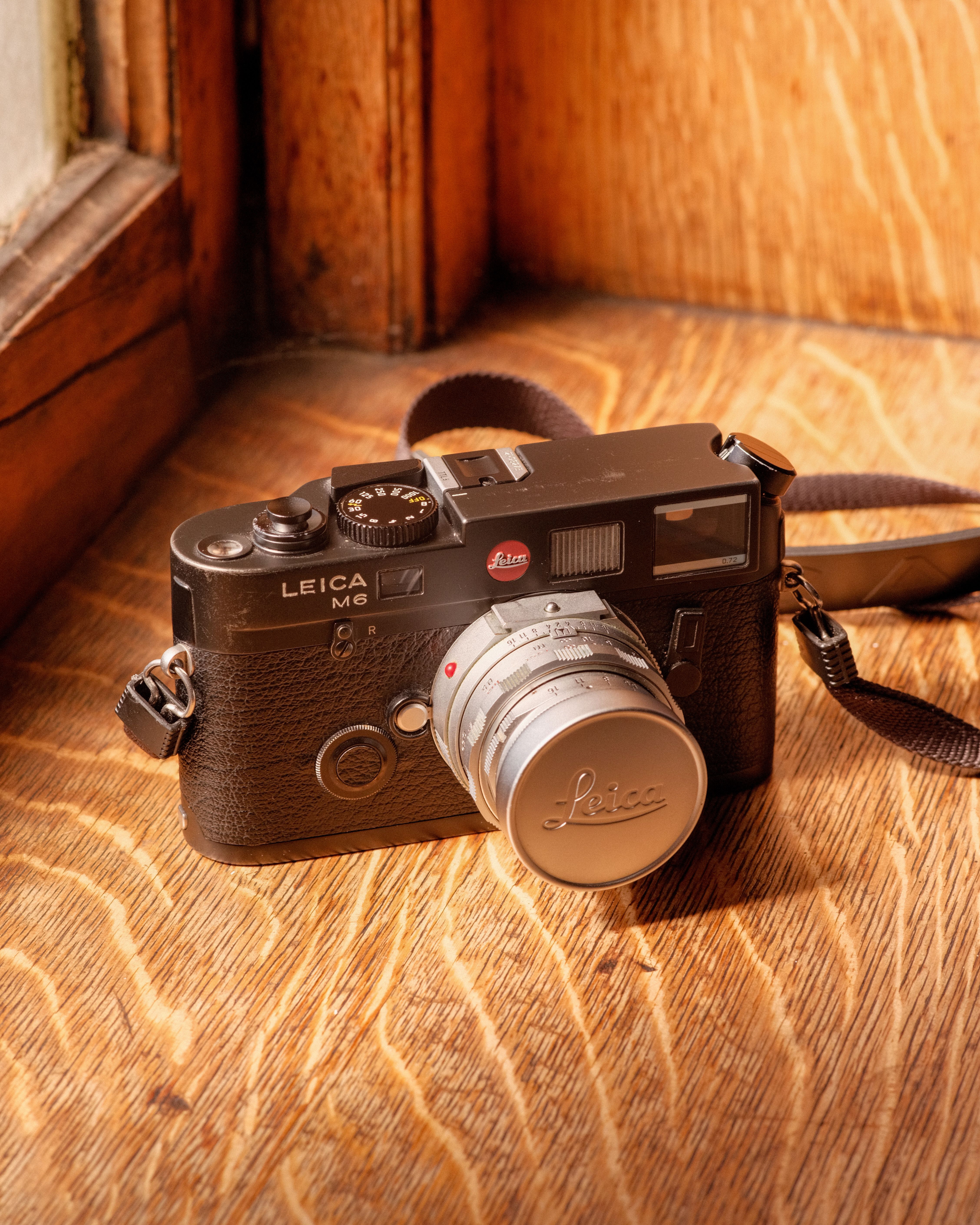 Analog Leica Camera on Wooden Windowsill · Free Stock Photo