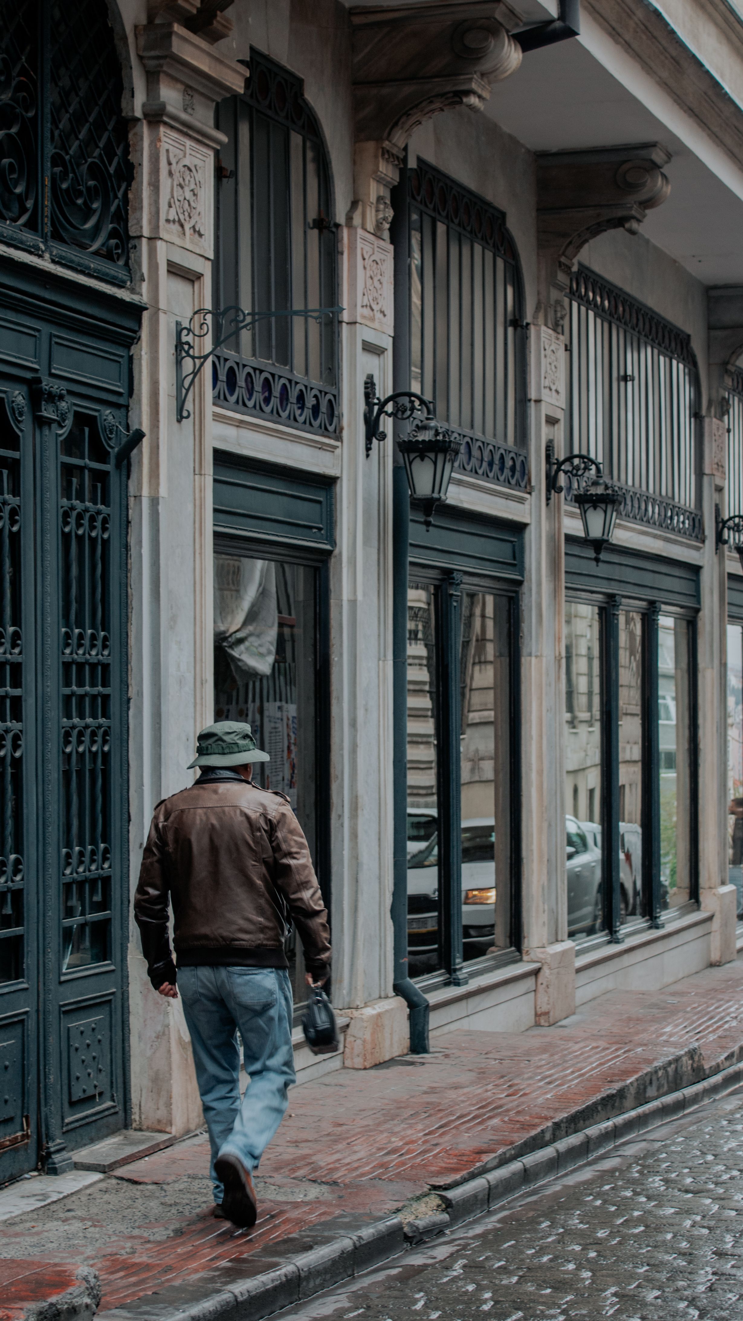 Man Walking Next to a Tenement · Free Stock Photo