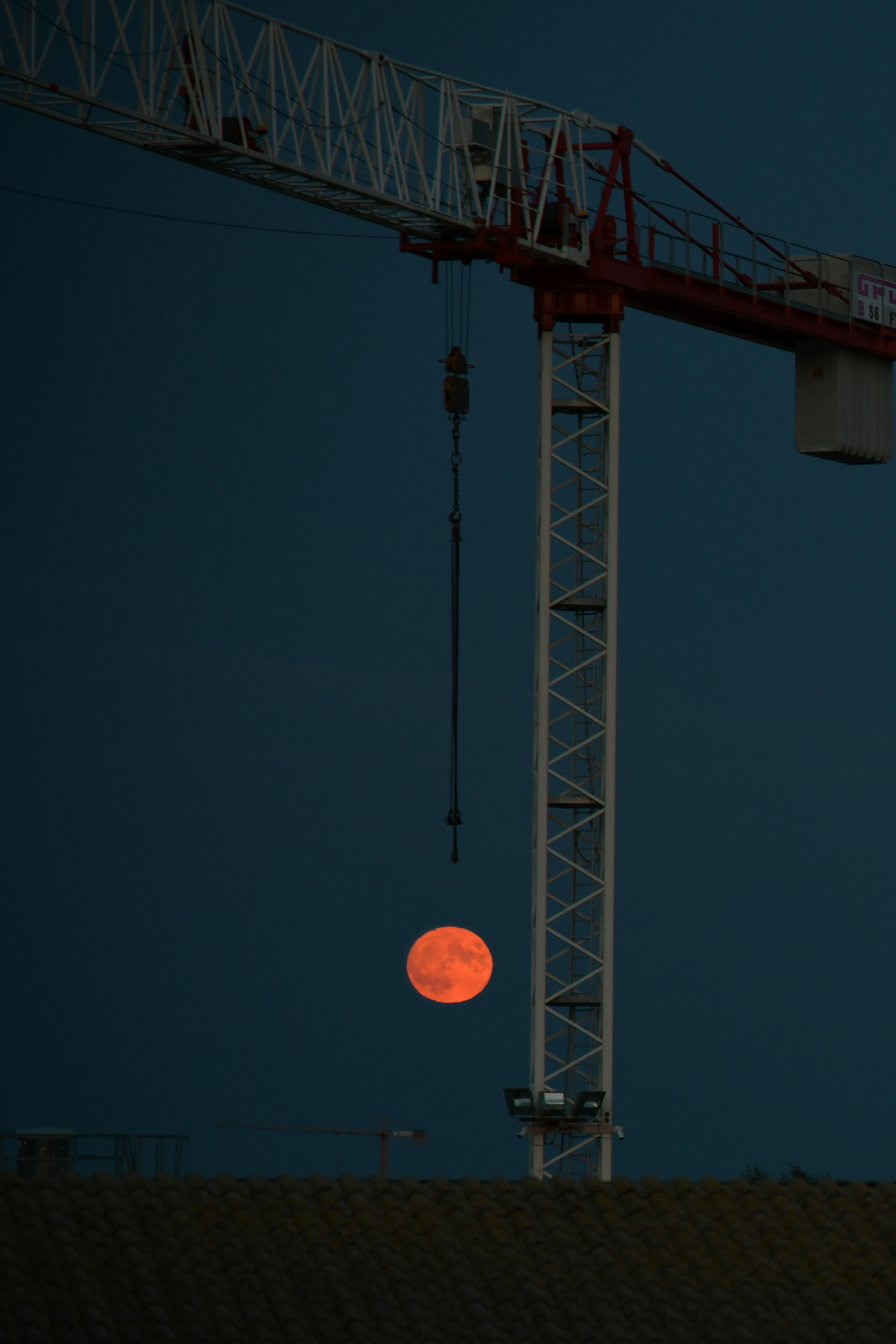 Construction Crane over Eclipse of Moon · Free Stock Photo