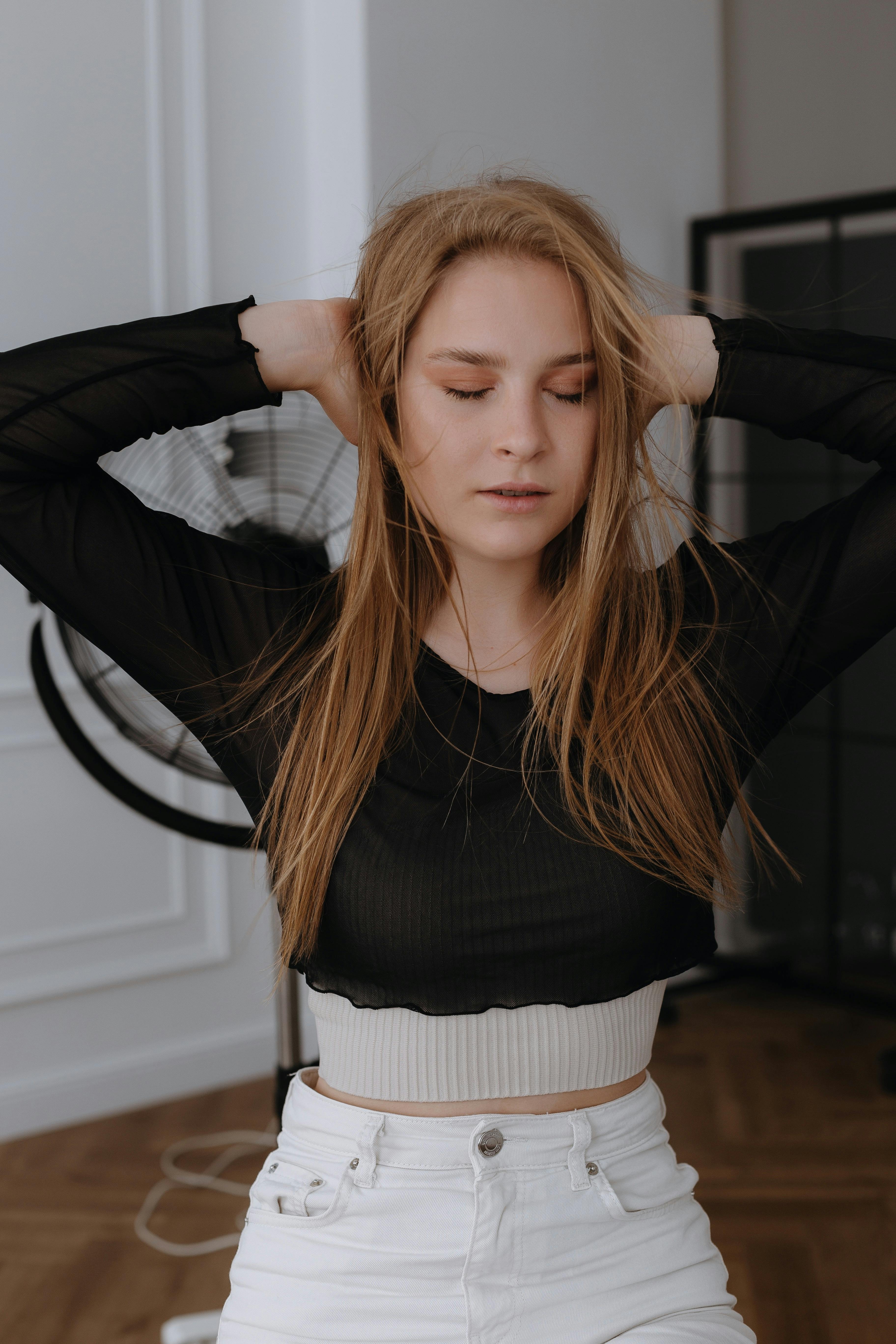 Photo Of A Slim Girl Wearing A Black Bra And White Shorts Posing