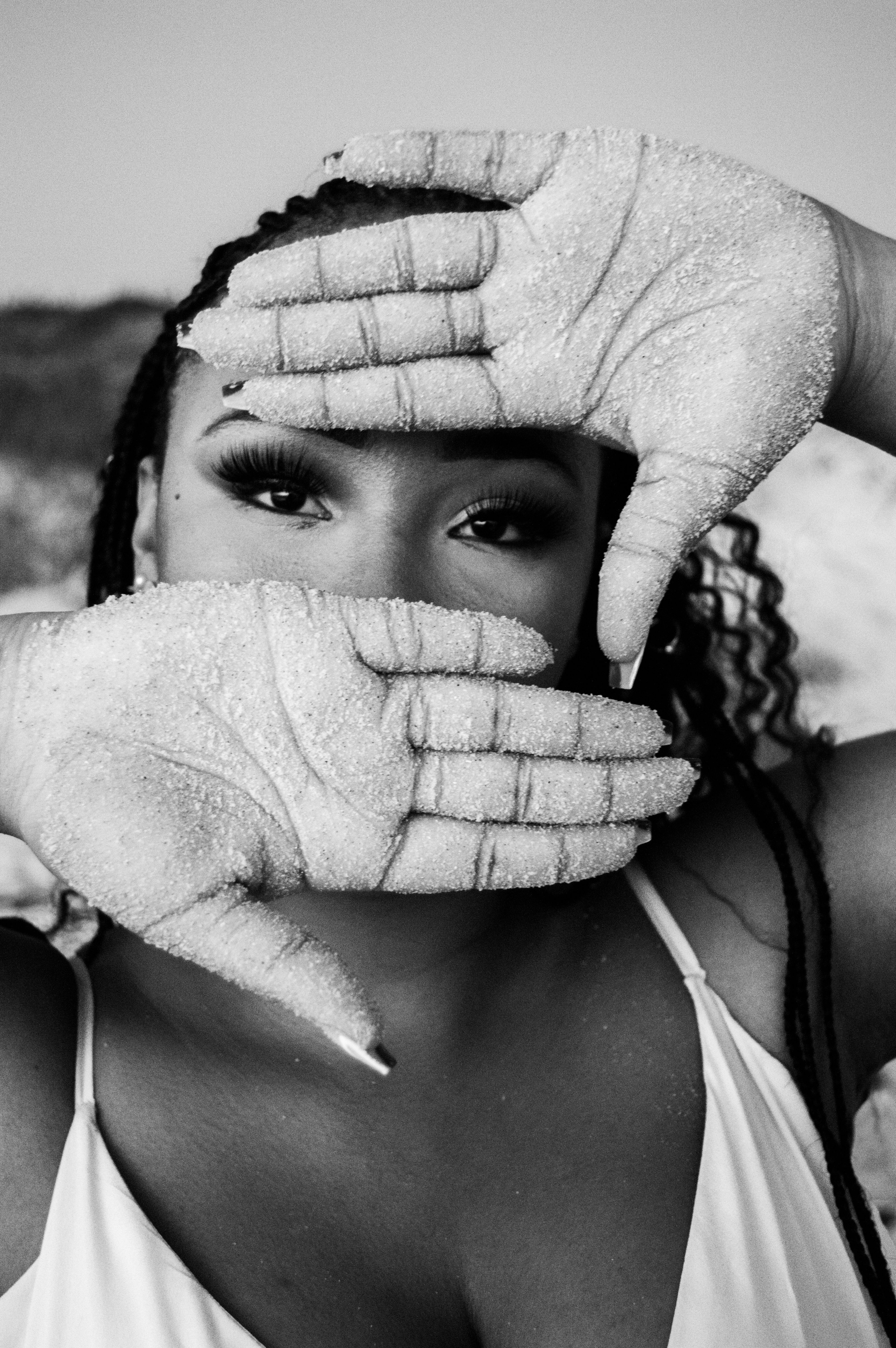 Portrait of Woman Covering Face with Hands in Sand · Free Stock Photo