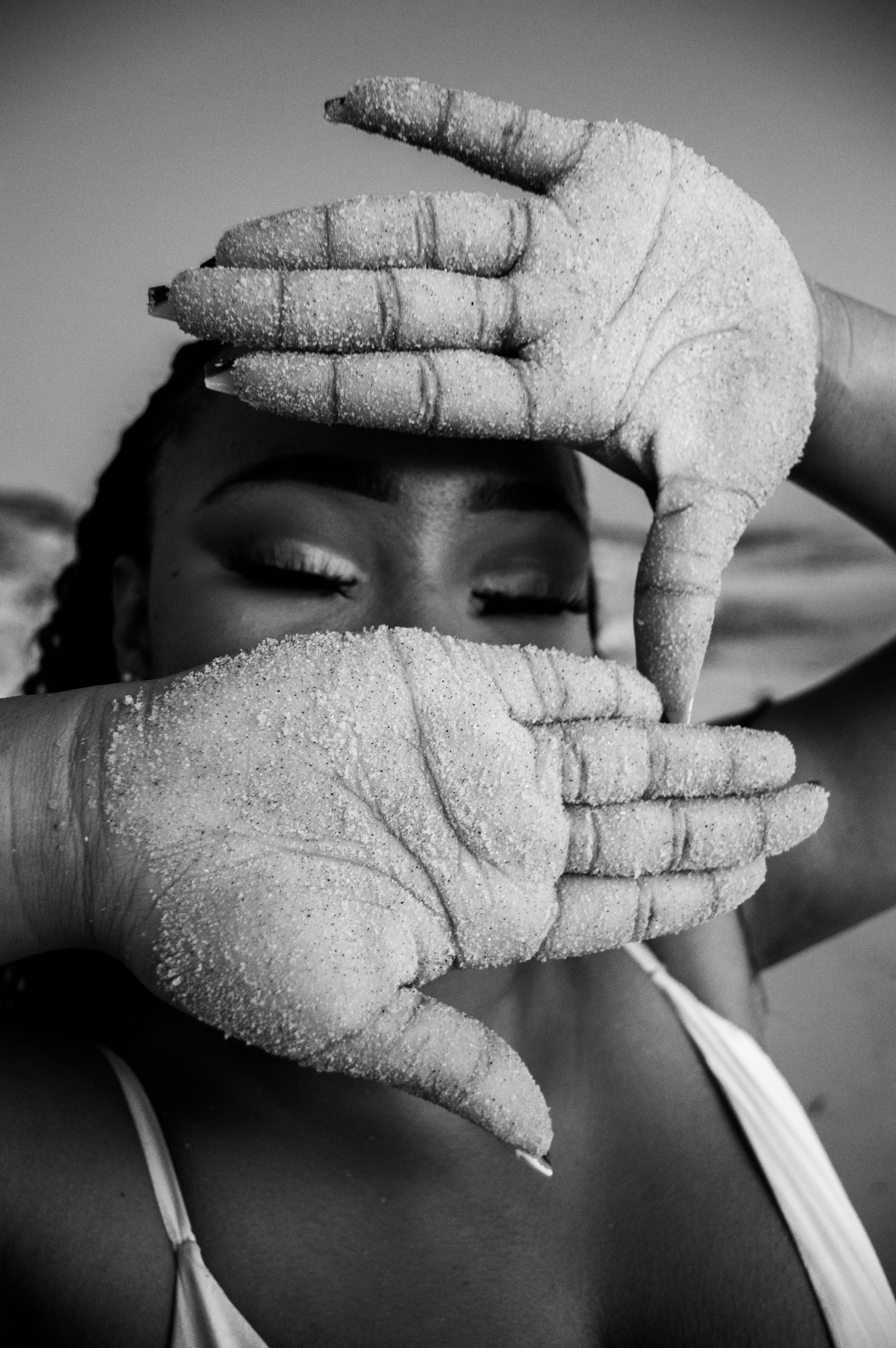 Portrait of Woman Covering Face with Hands in Sand · Free Stock Photo