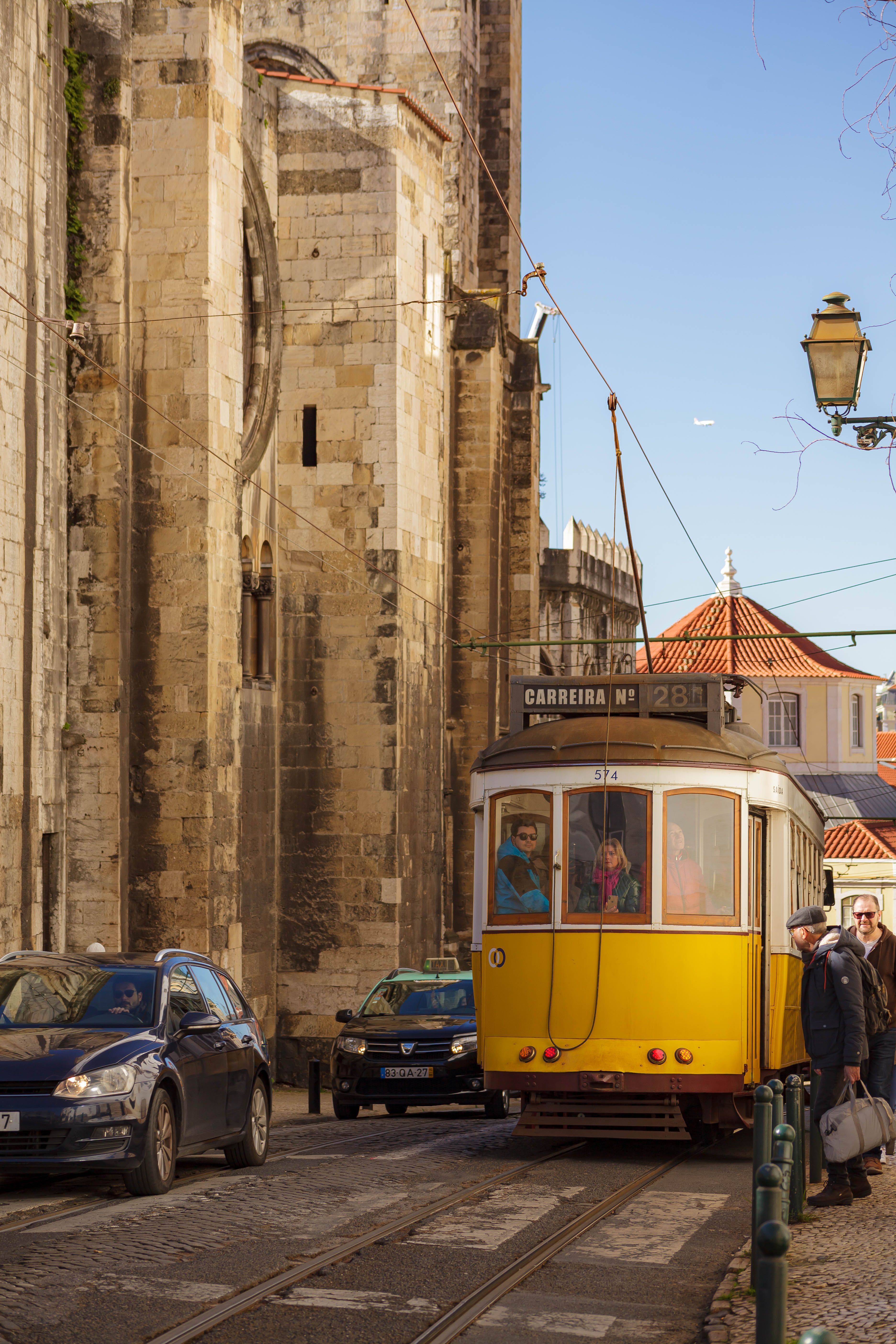 Old Tram near Stone Historic Building in City · Free Stock Photo