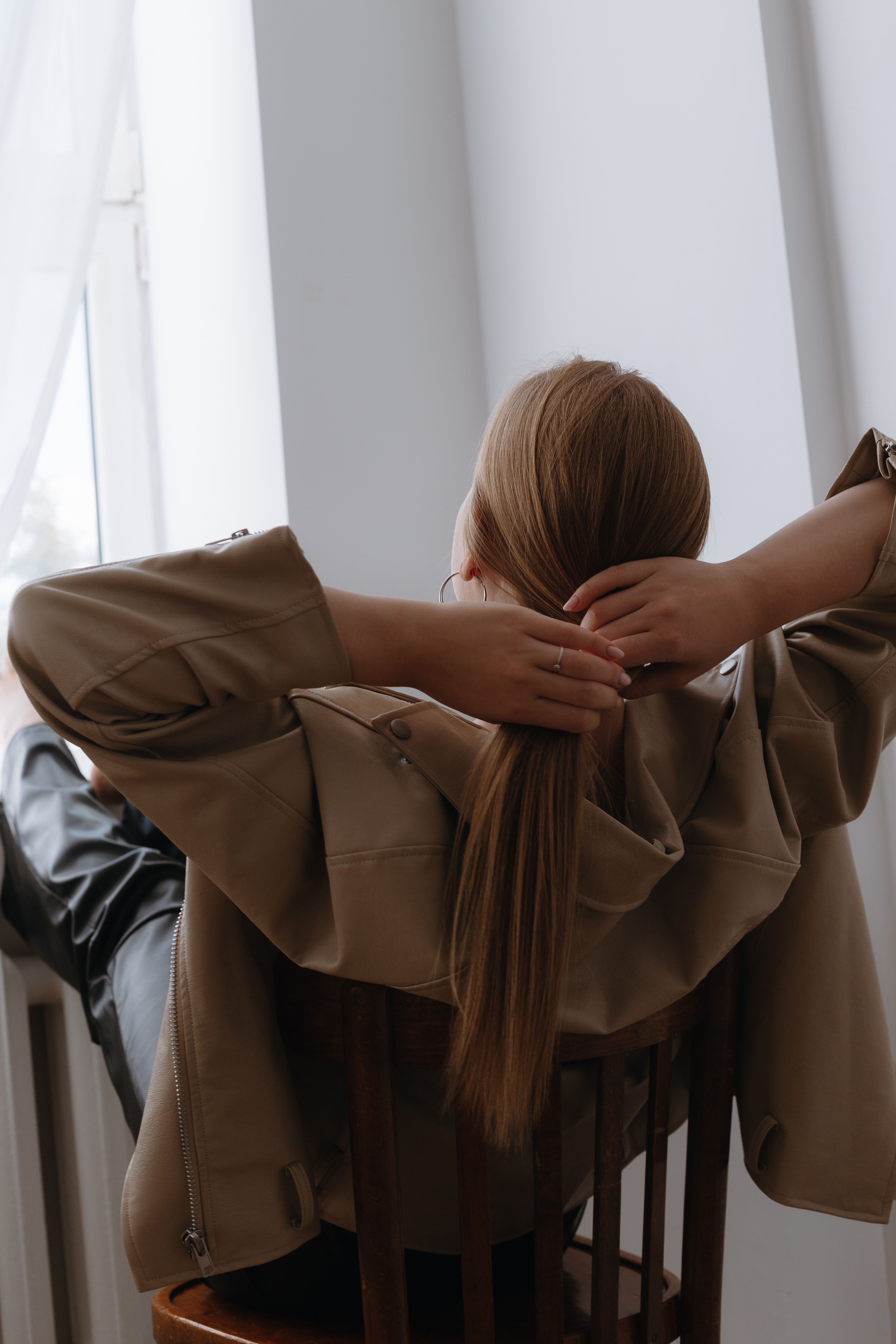 Woman in Leather Jacket and Pants Sitting on Chair · Free Stock Photo
