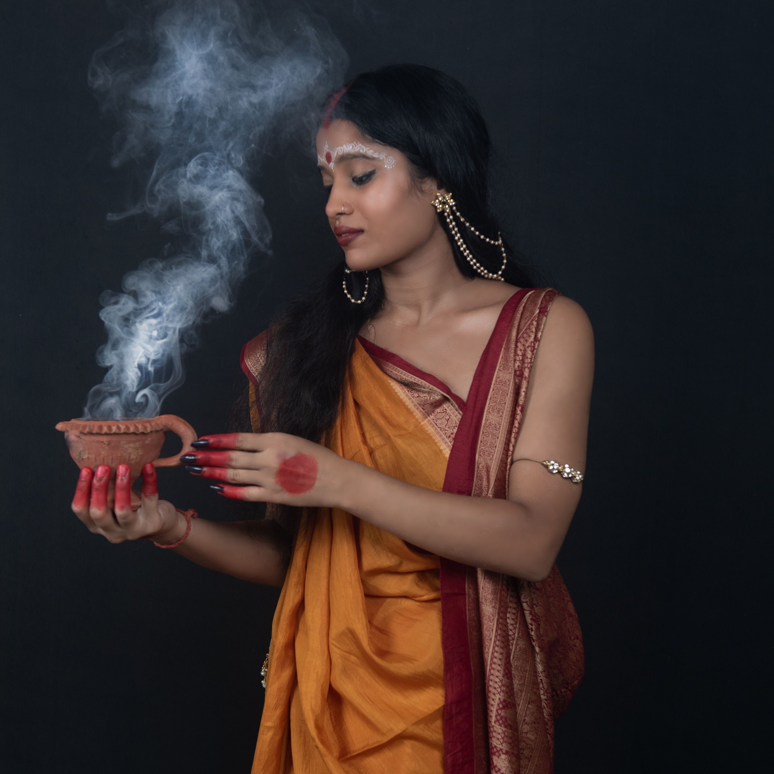 Woman in Lehenga Dress Holding Smoking Pot · Free Stock Photo