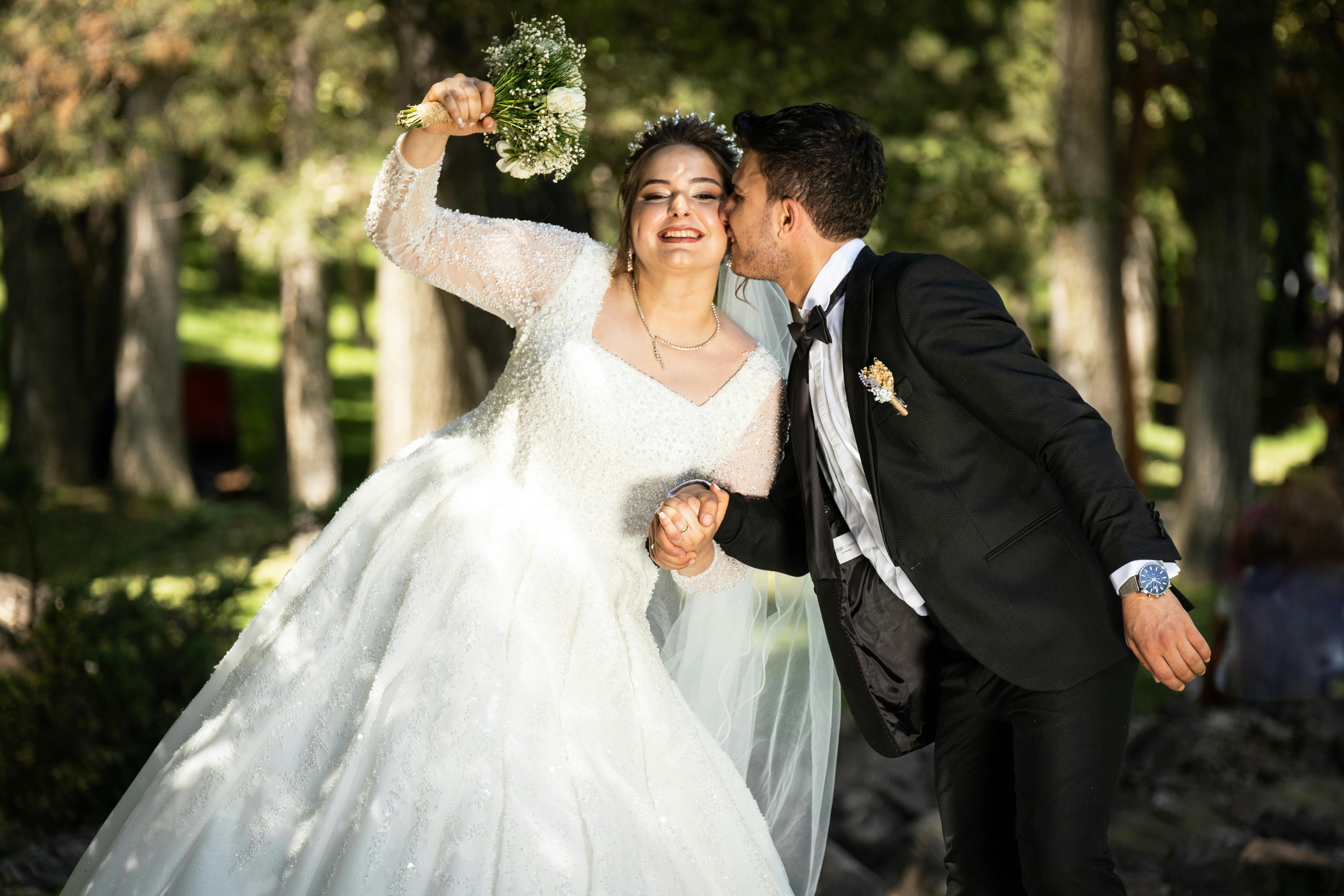 Groom Kissing the Bride on the Cheek · Free Stock Photo
