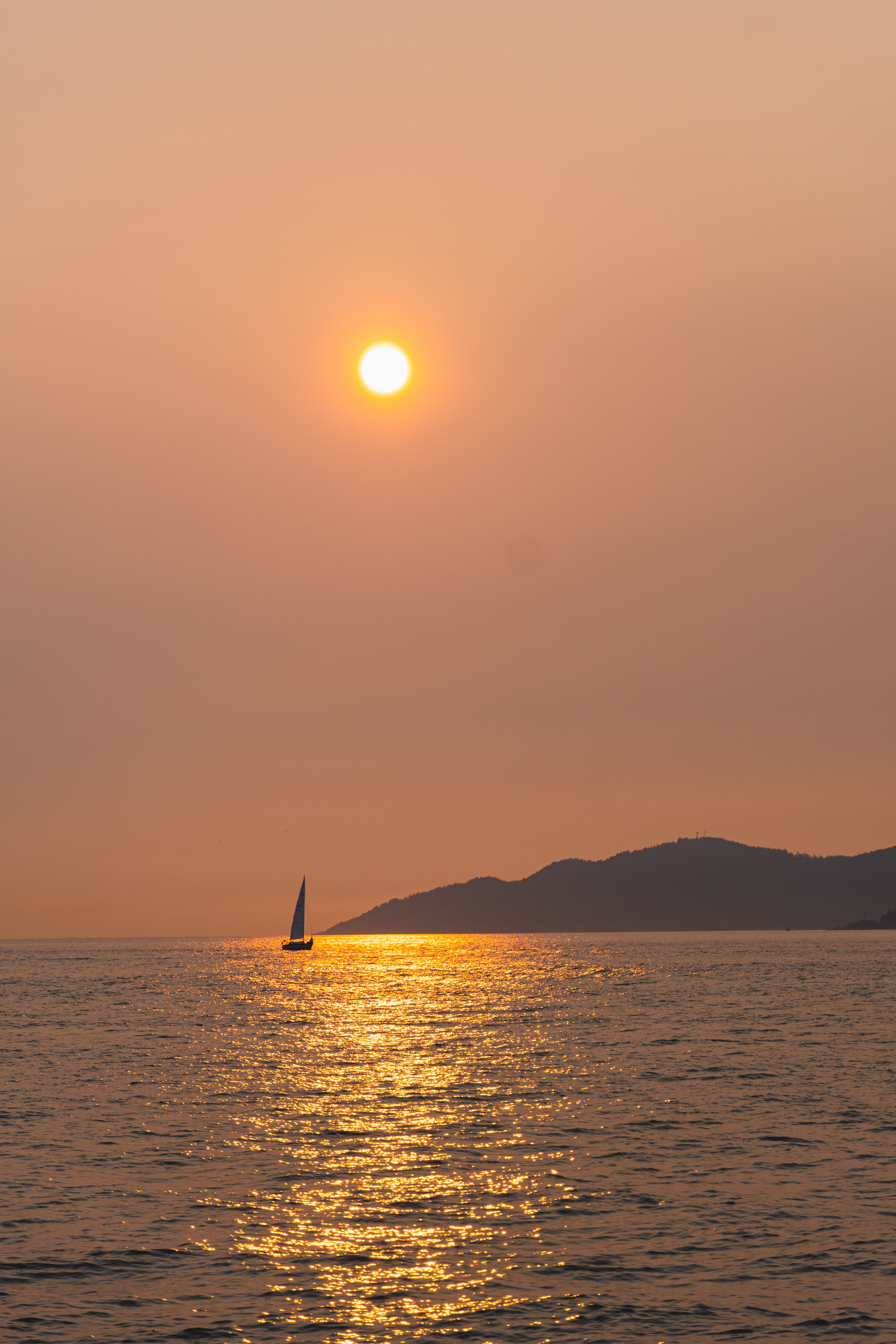 Sailboat on Sea Coast at Sunset · Free Stock Photo