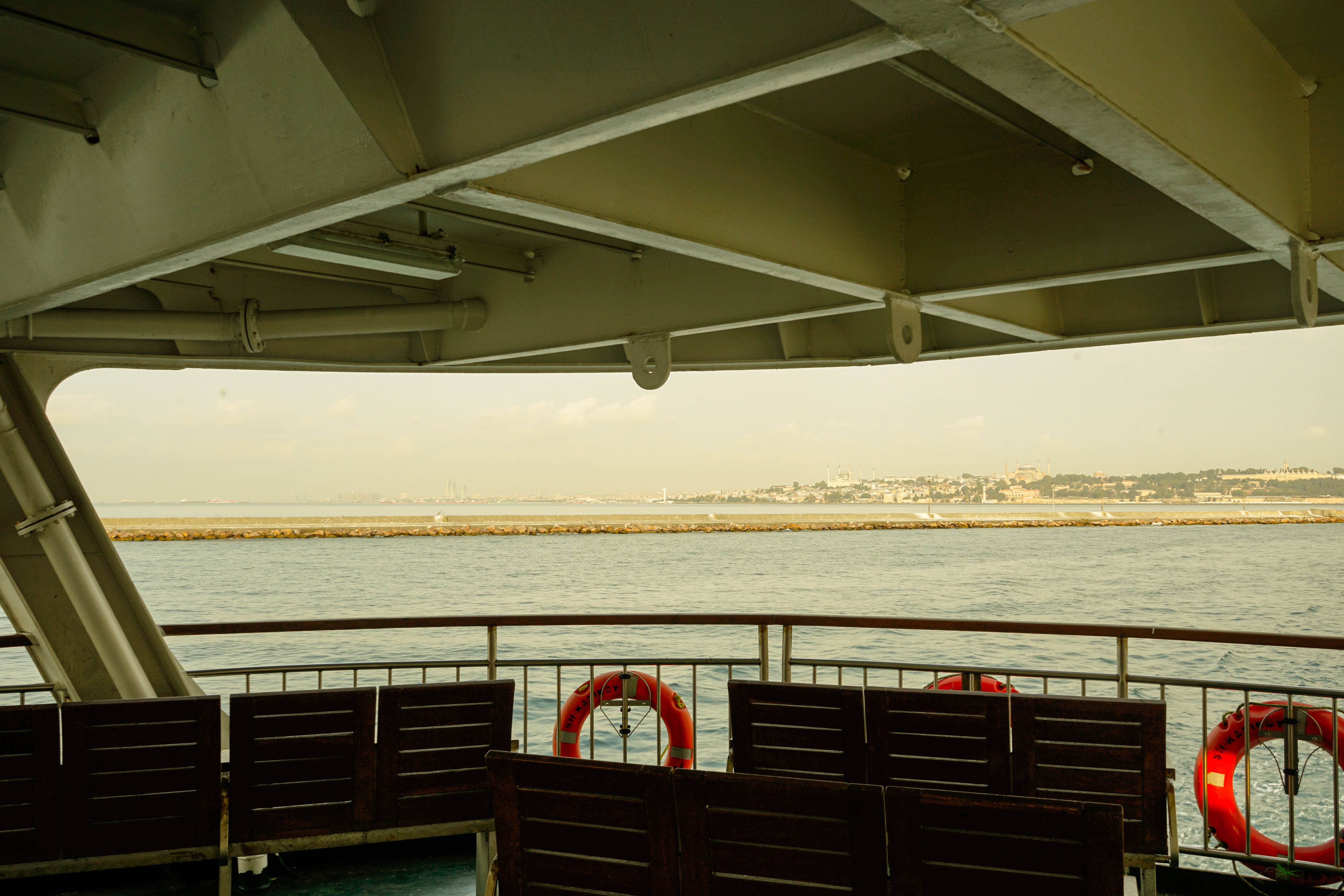 Sea behind Vessel Seats and Railing · Free Stock Photo