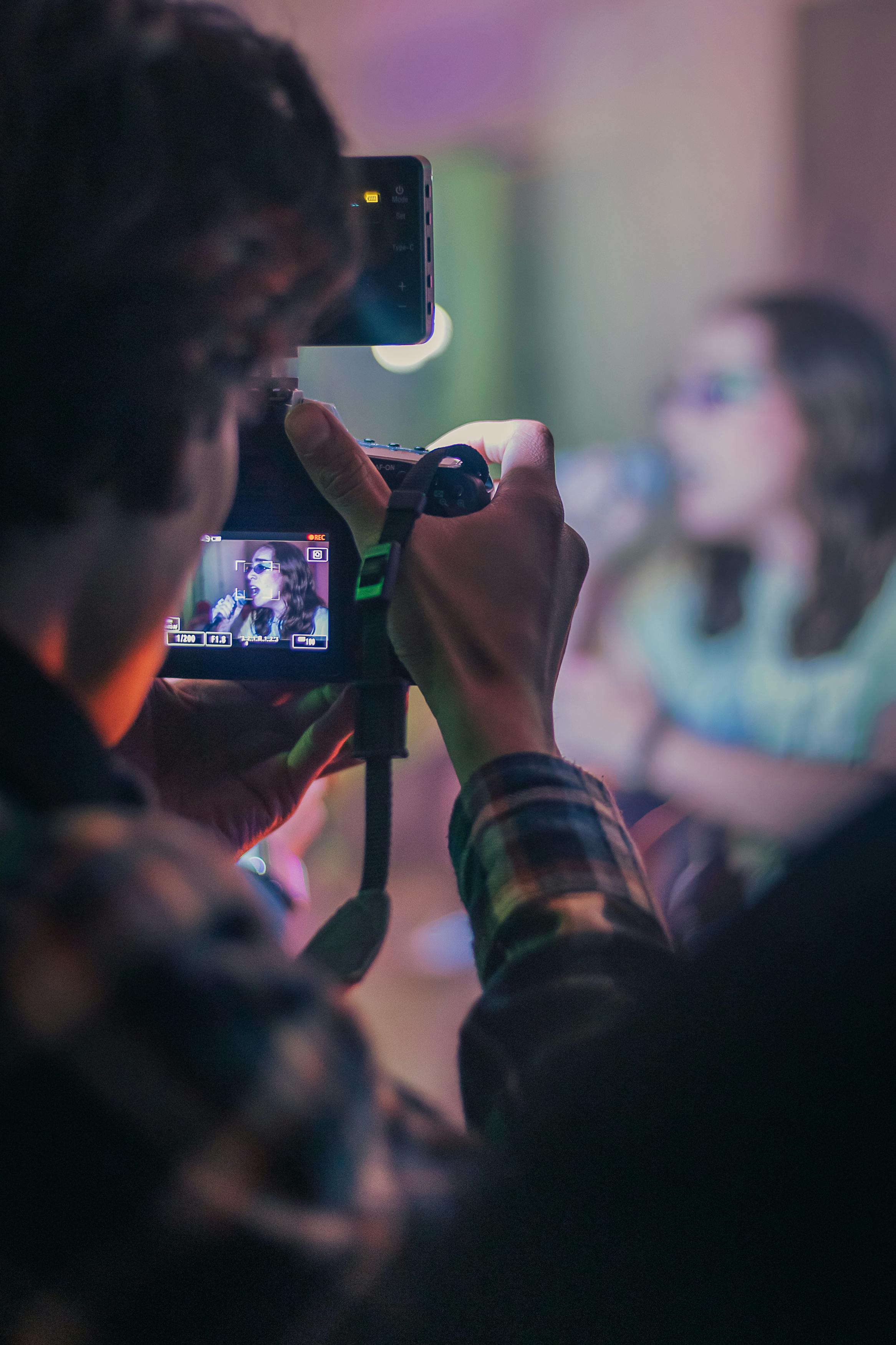 Photographer Taking Photos of a Singer During a Performance · Free ...