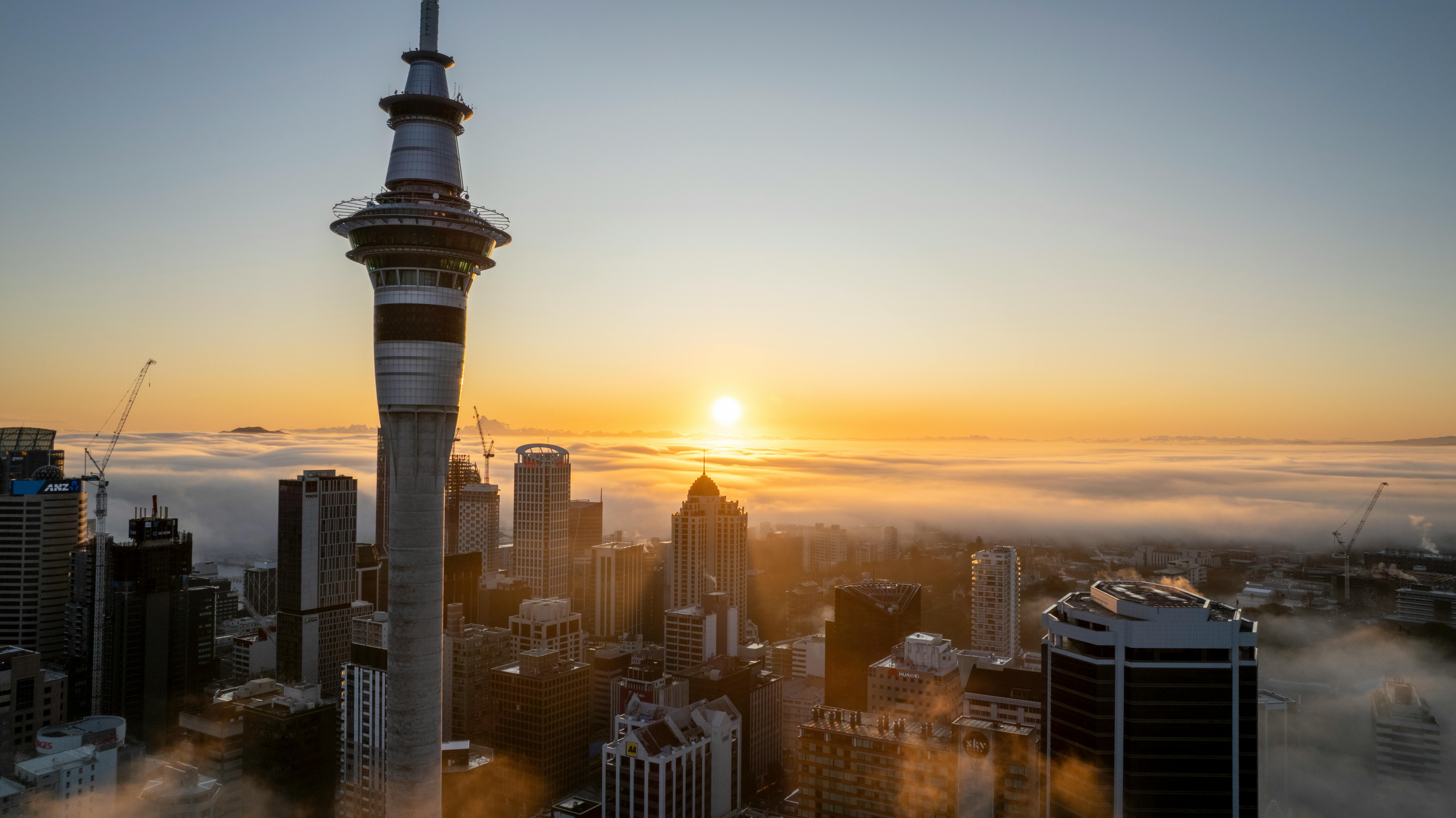 Sky Tower over Buildings in Auckland at Sunset · Free Stock Photo