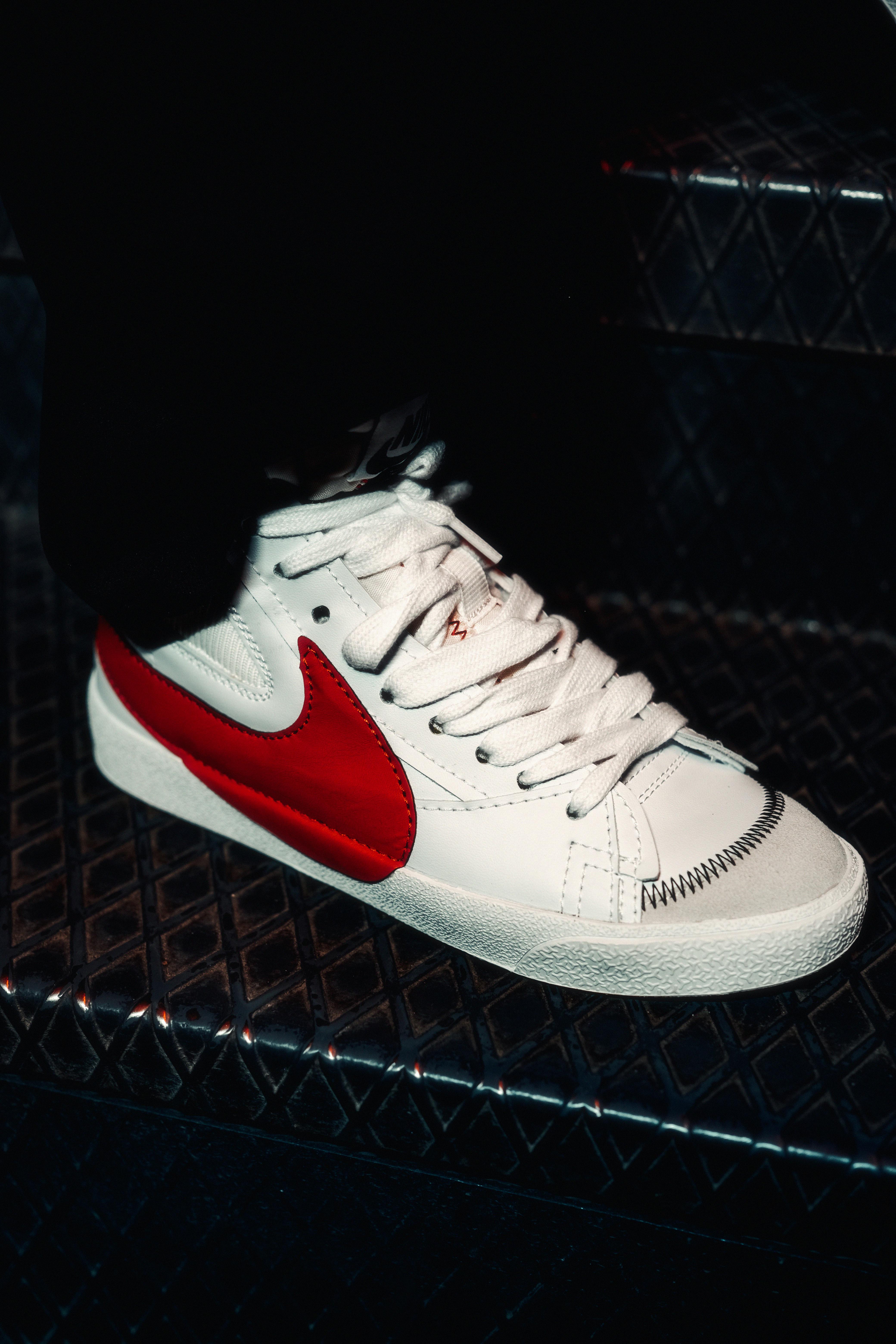 White Trainer with Red Company Emblem · Free Stock Photo