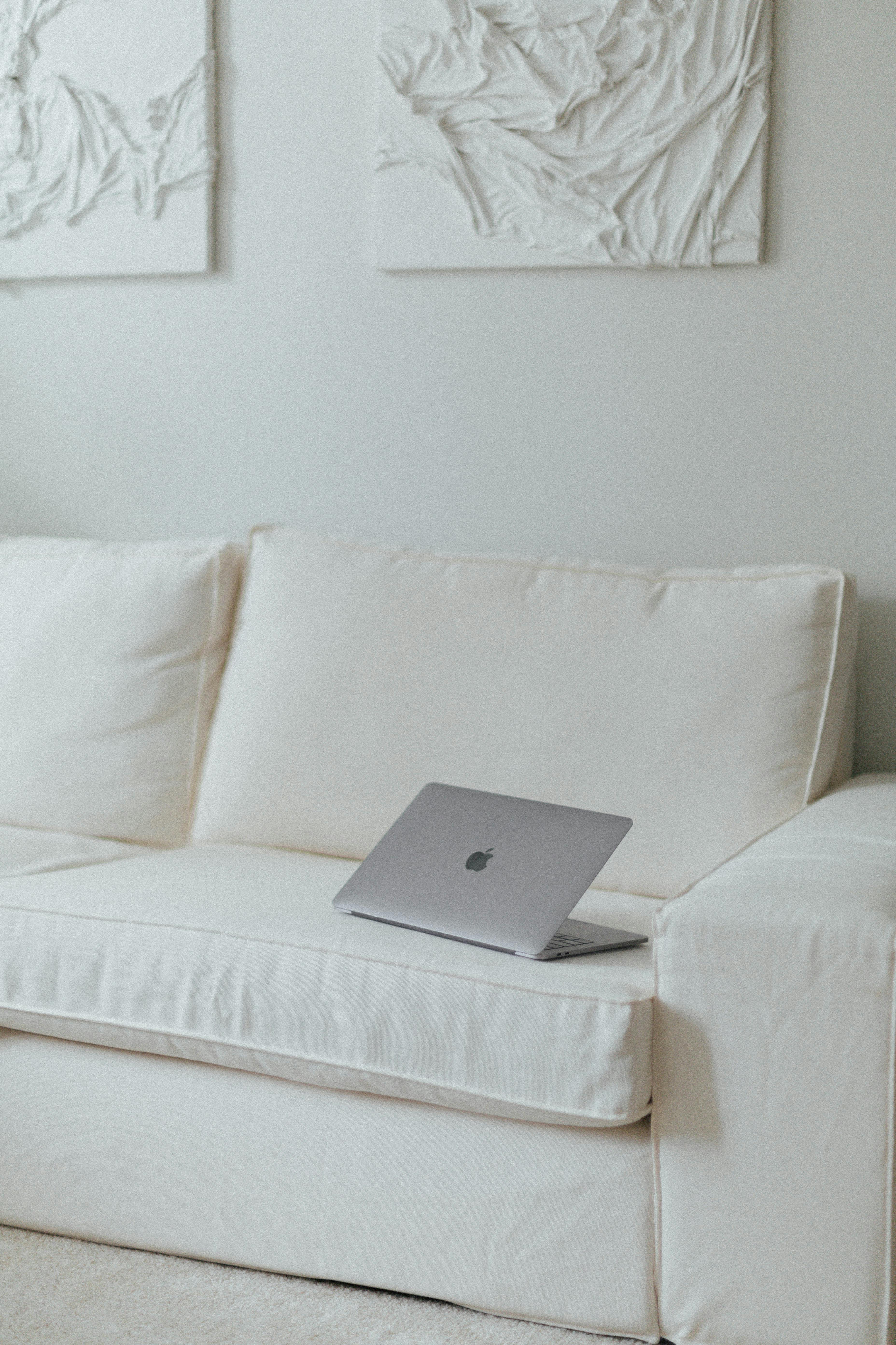 A Laptop on a Sofa in a Room with Minimalist Decor · Free Stock Photo