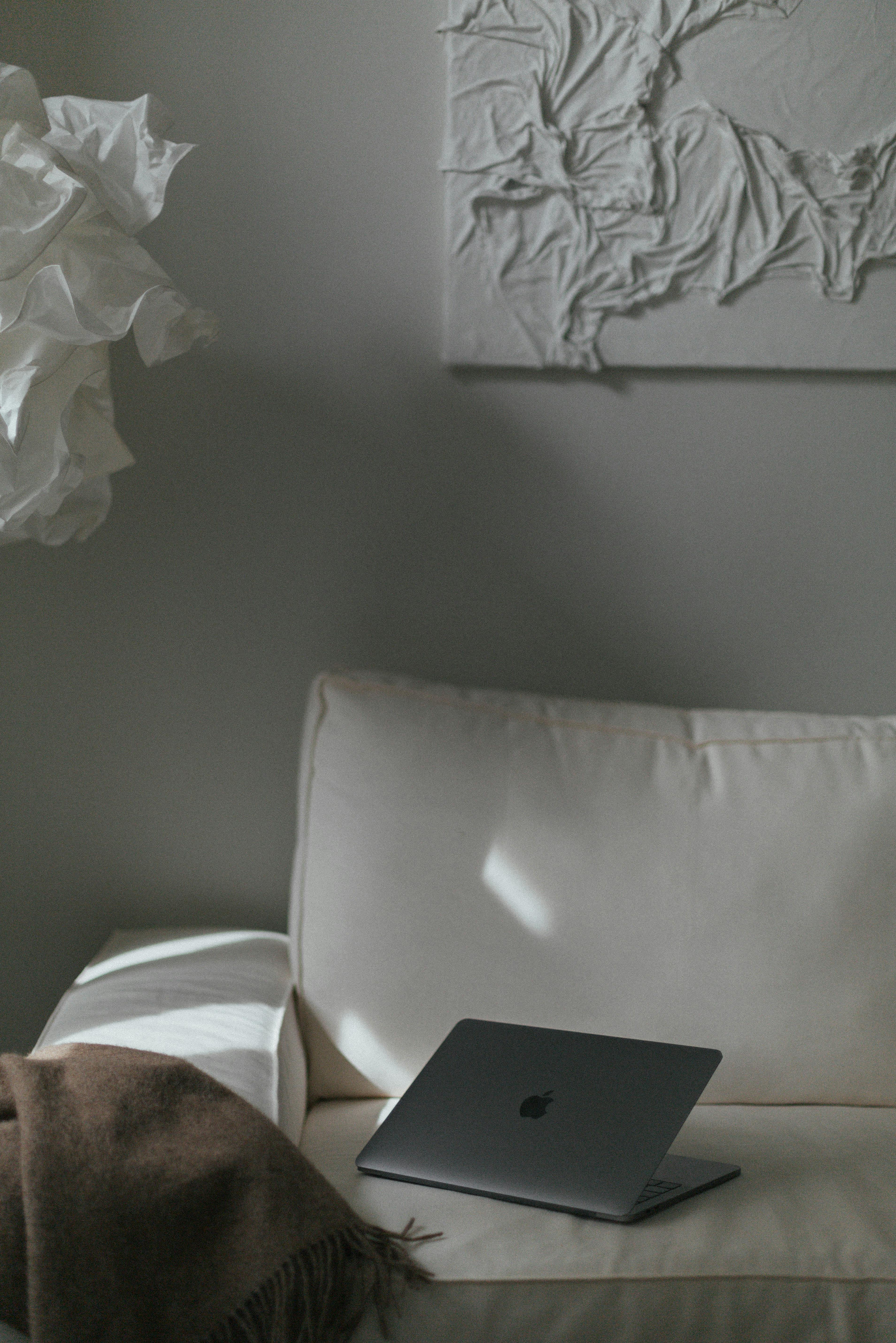 Apple Macbook on Sofa · Free Stock Photo