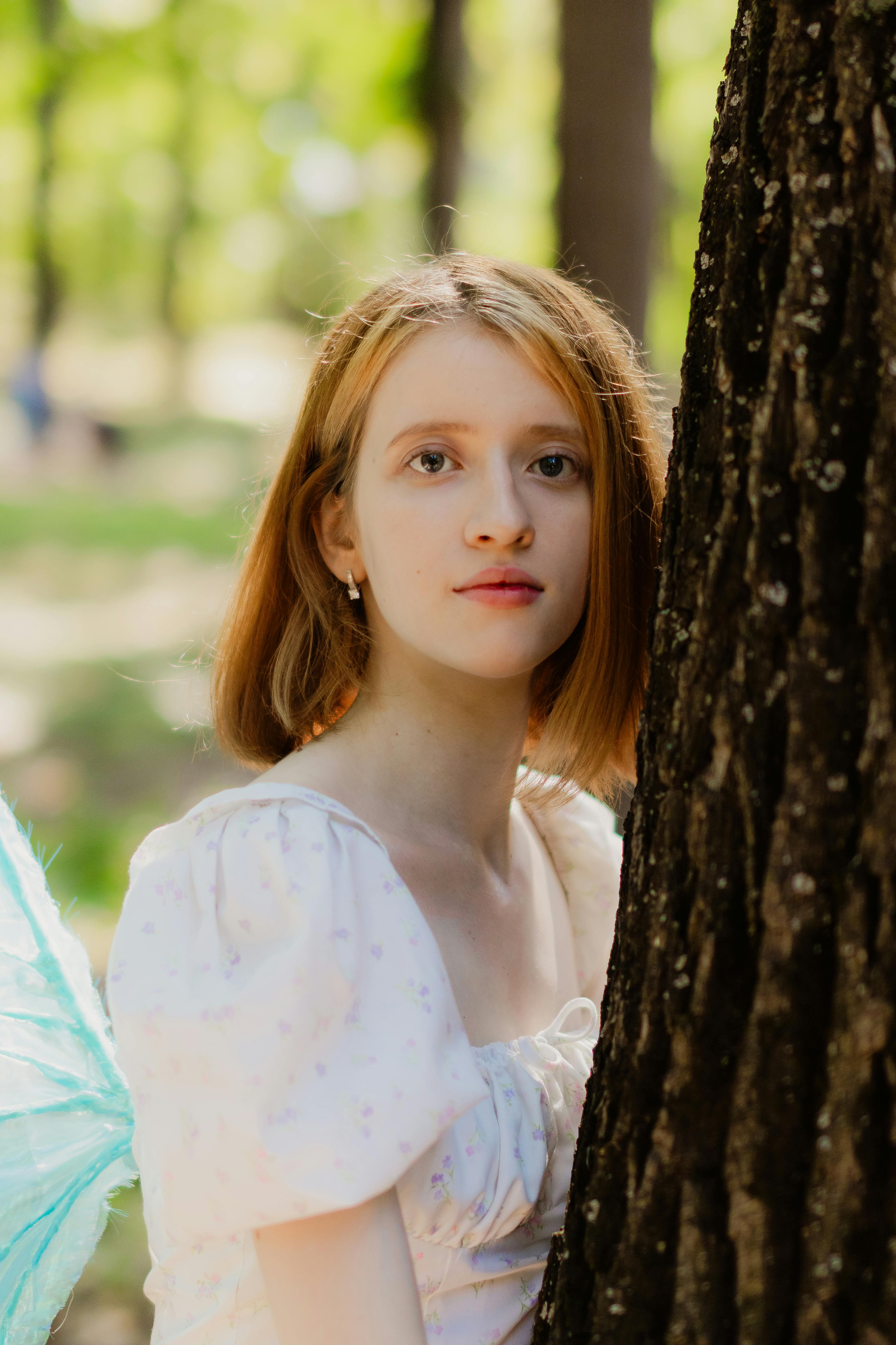 Cute Redheaded Girl by the Tree · Free Stock Photo