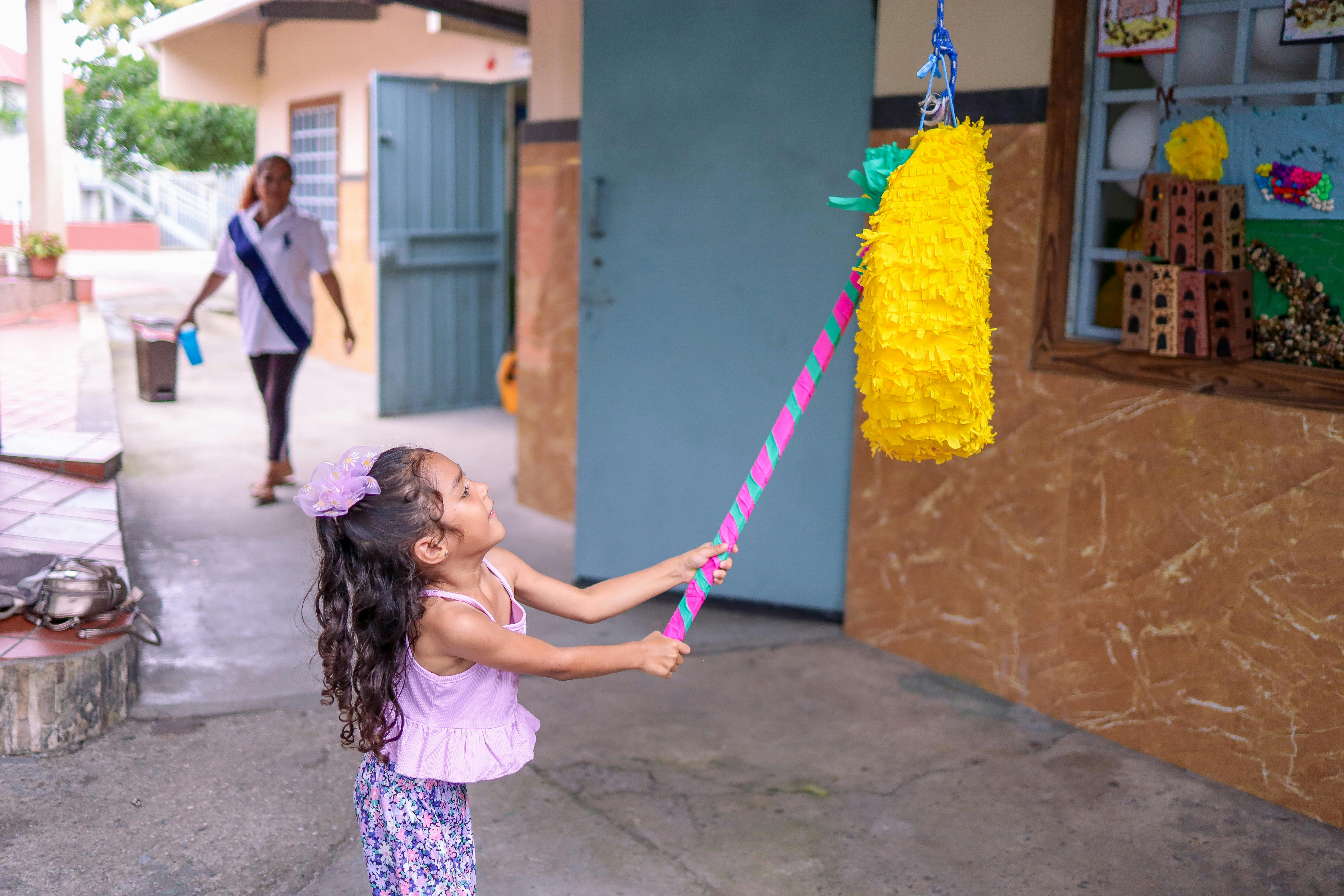 Girl Hitting Pinata · Free Stock Photo