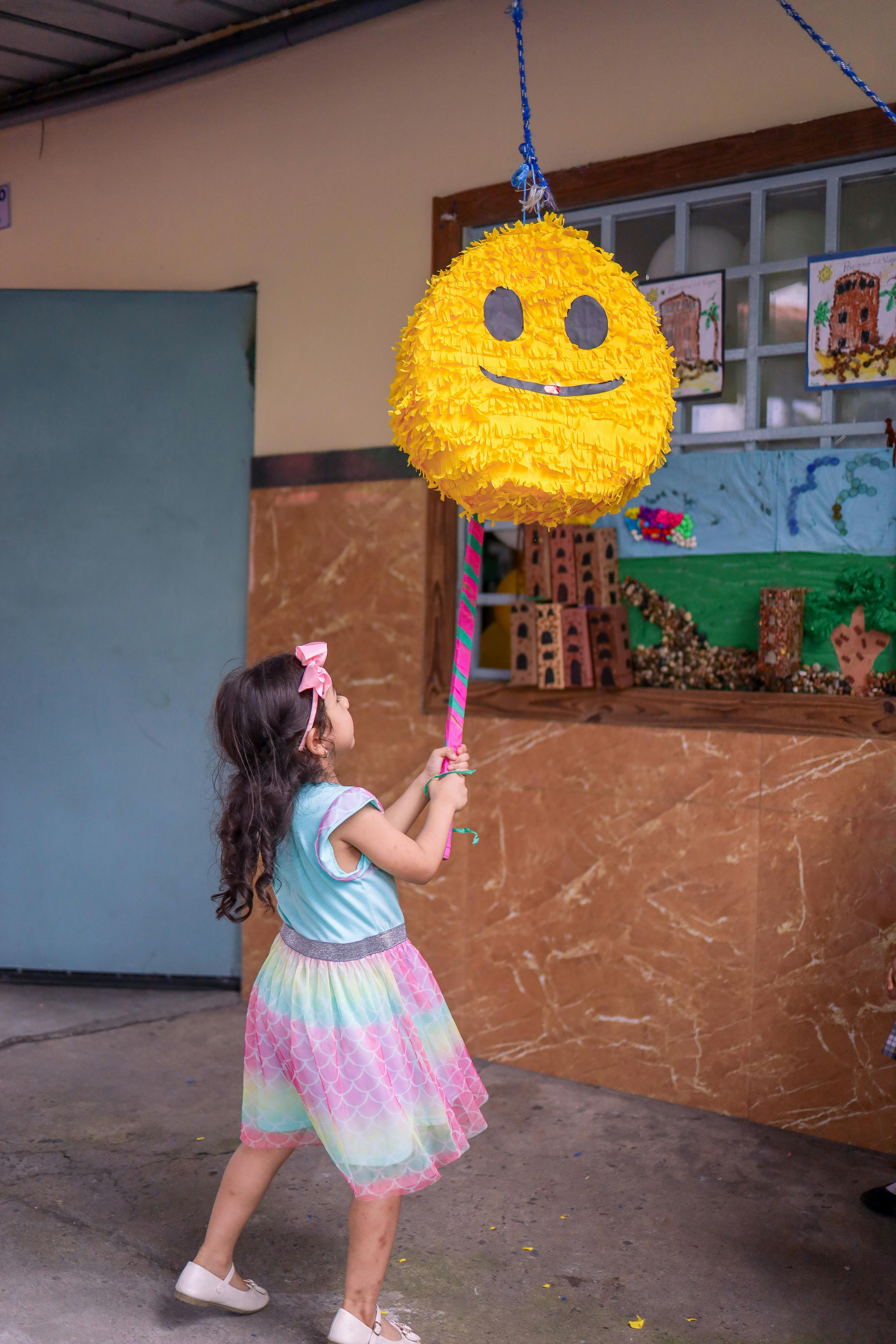 Girl Playing with Pinata · Free Stock Photo
