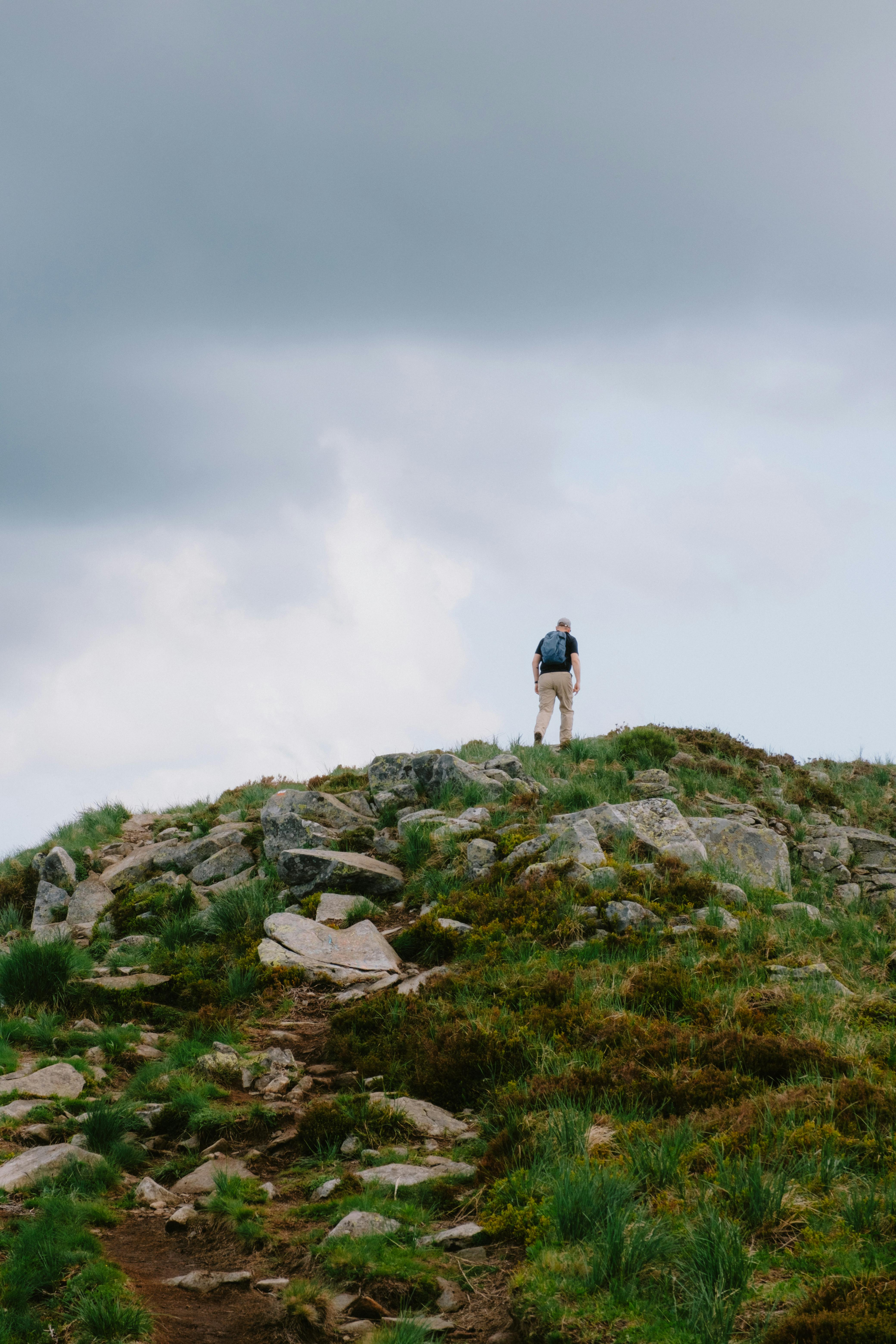 Rain Cloud over Man Hiking on Hill · Free Stock Photo