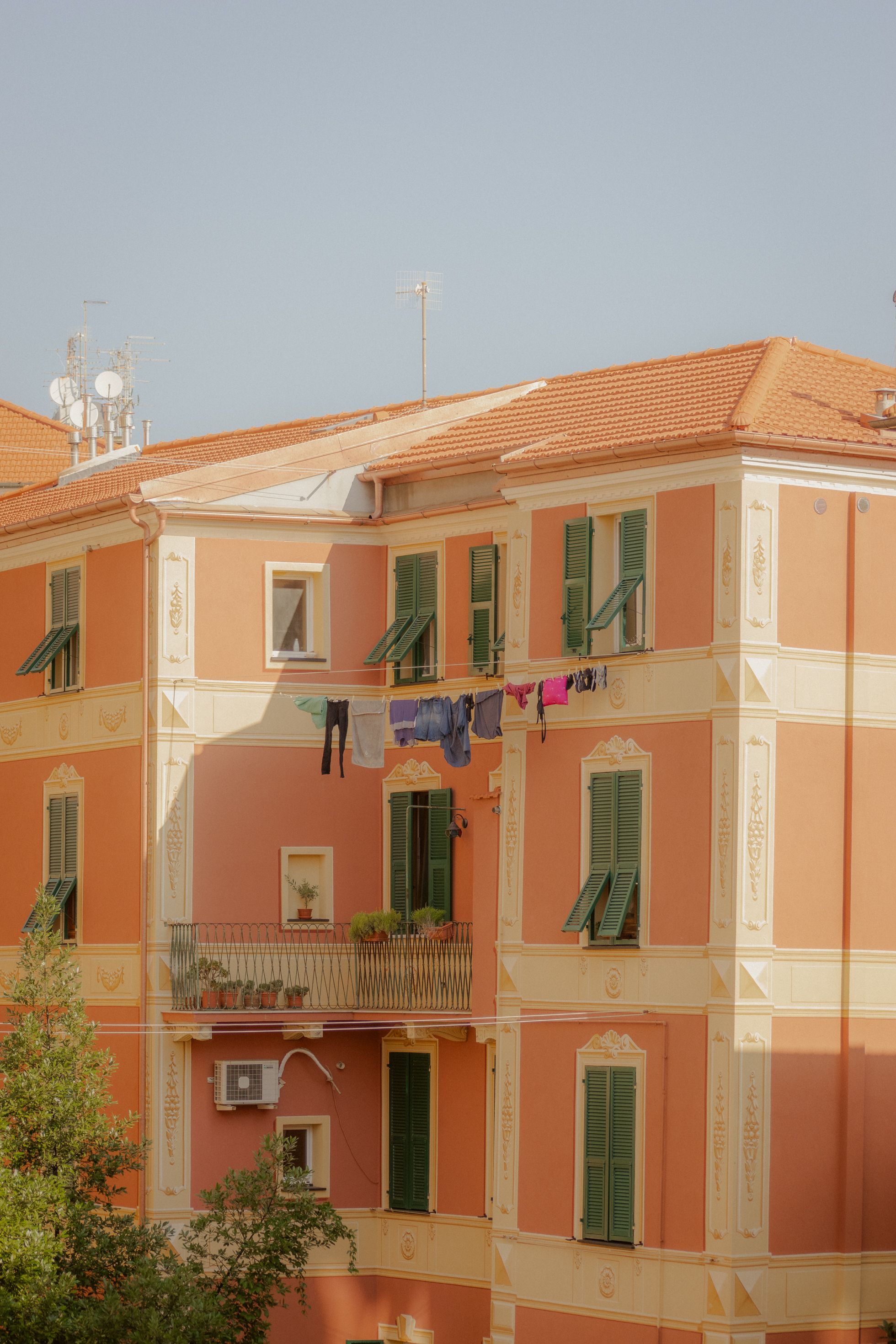 Exterior of an Apartment Building in a Pastel Pink Color with Green ...