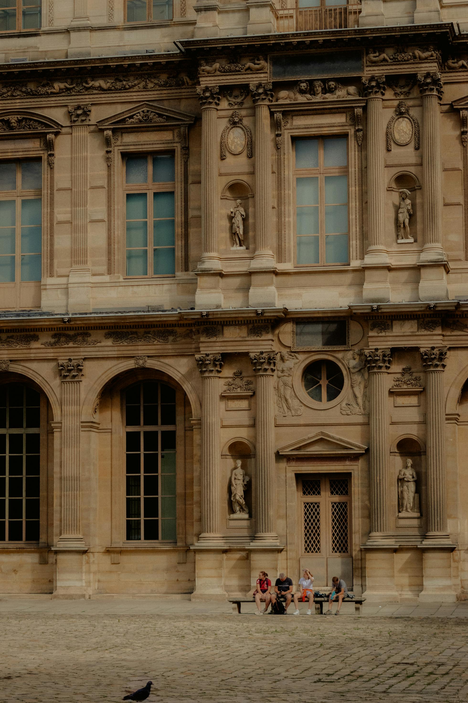 People Sitting by Louvre Wall · Free Stock Photo