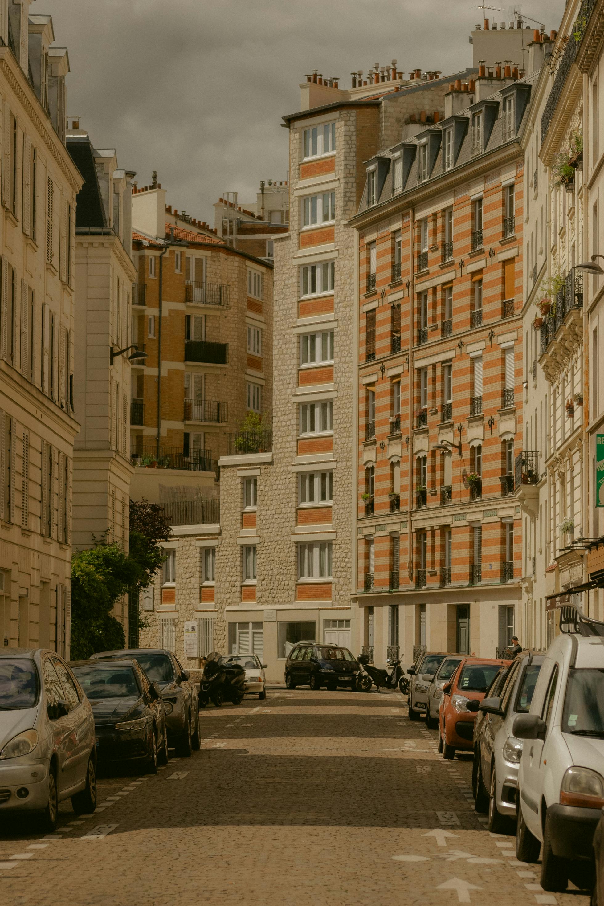 View of a Road between Apartment Buildings in City with Cars Parked on ...
