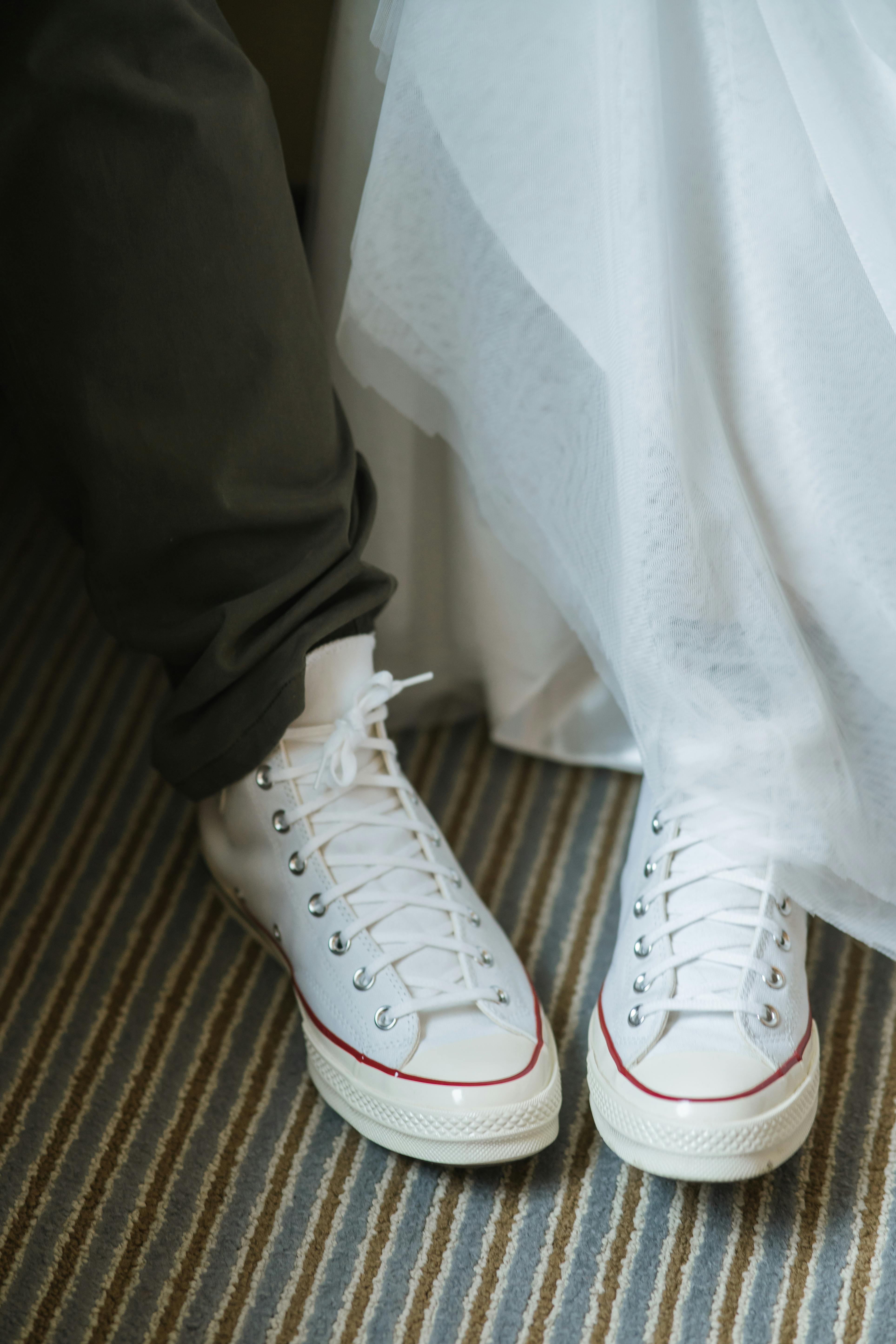 Legs in White Trainers with Red Lines · Free Stock Photo